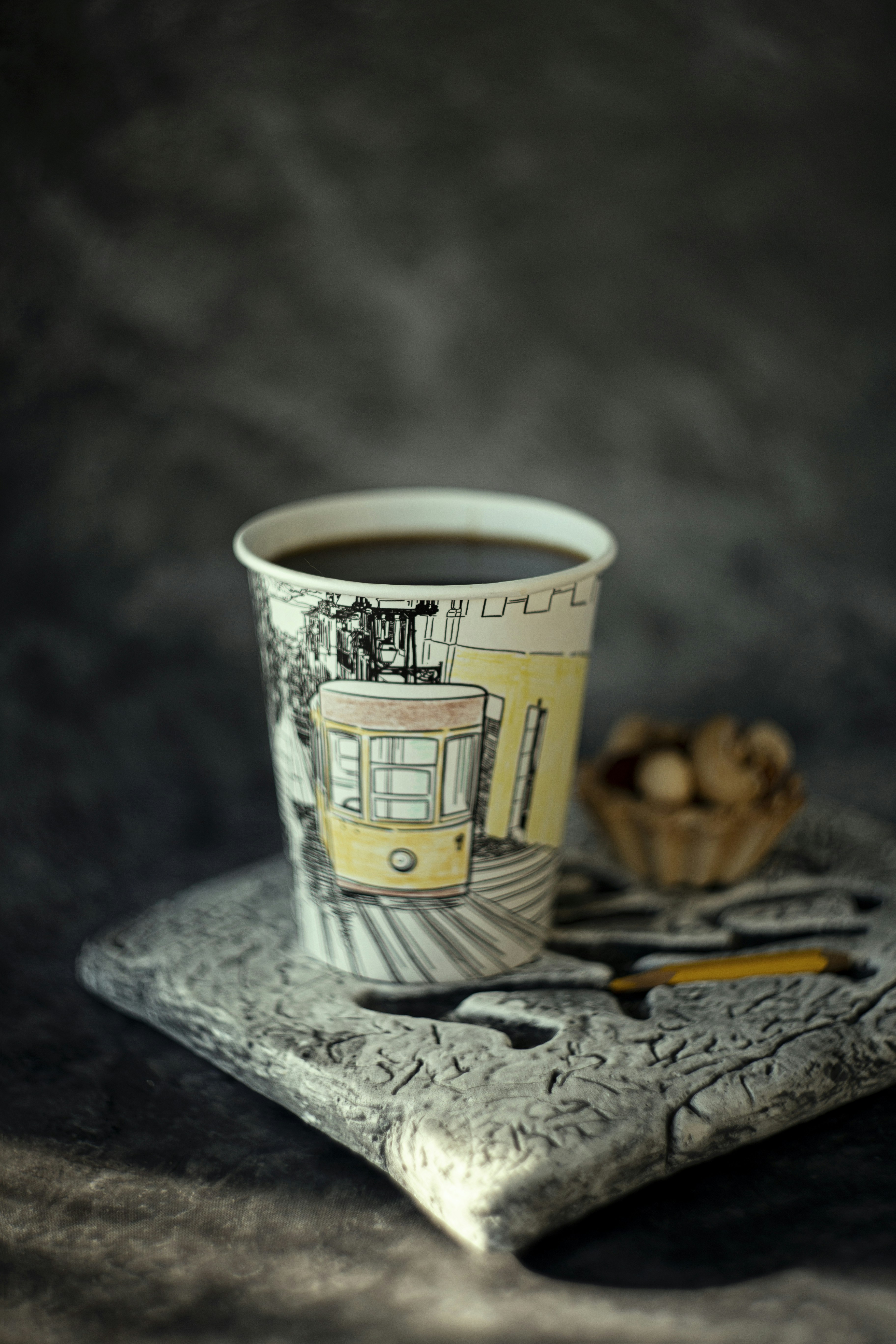 a cup of coffee sitting on top of a coaster