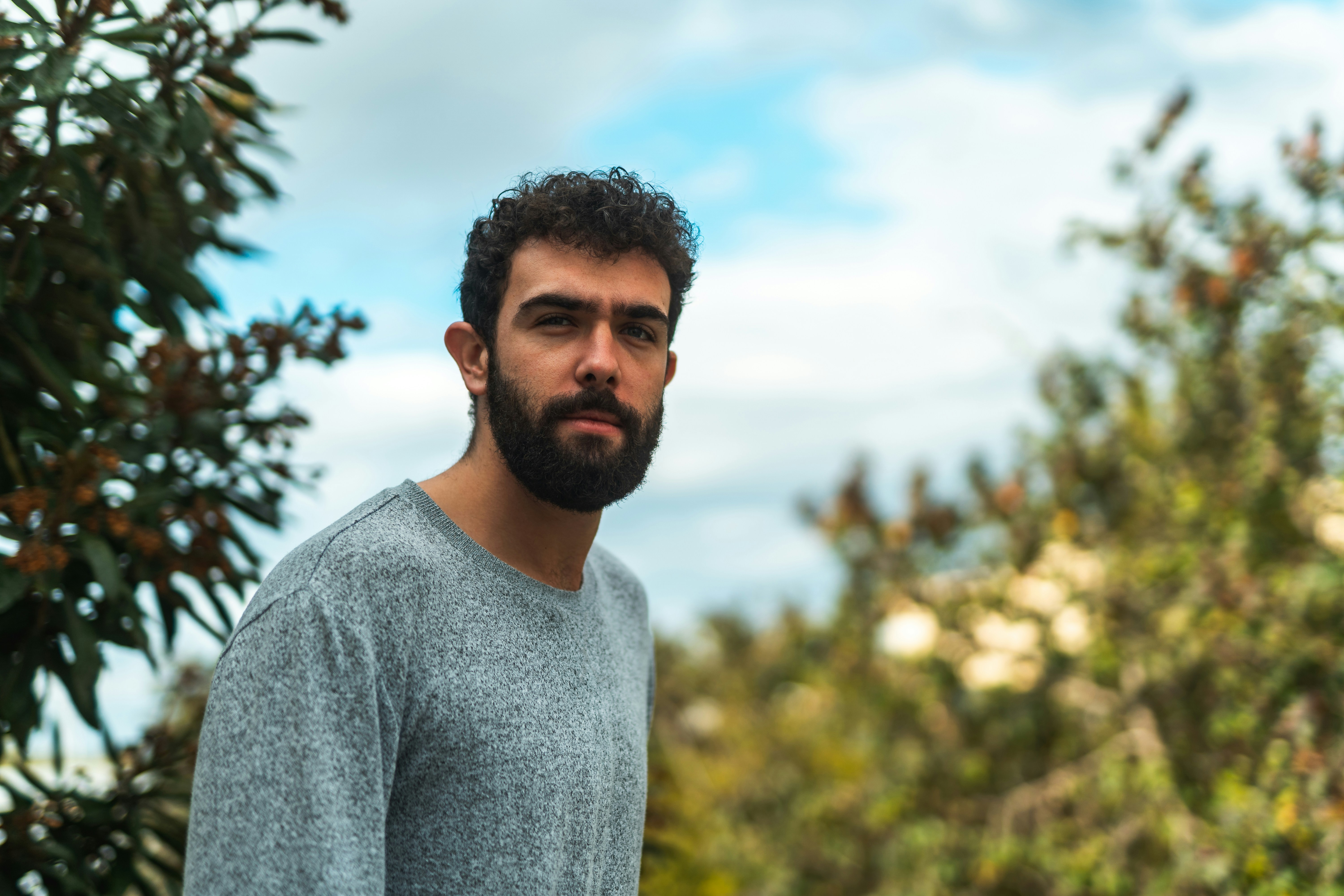 A man with a beard standing in front of trees photo – Free Israel Image ...