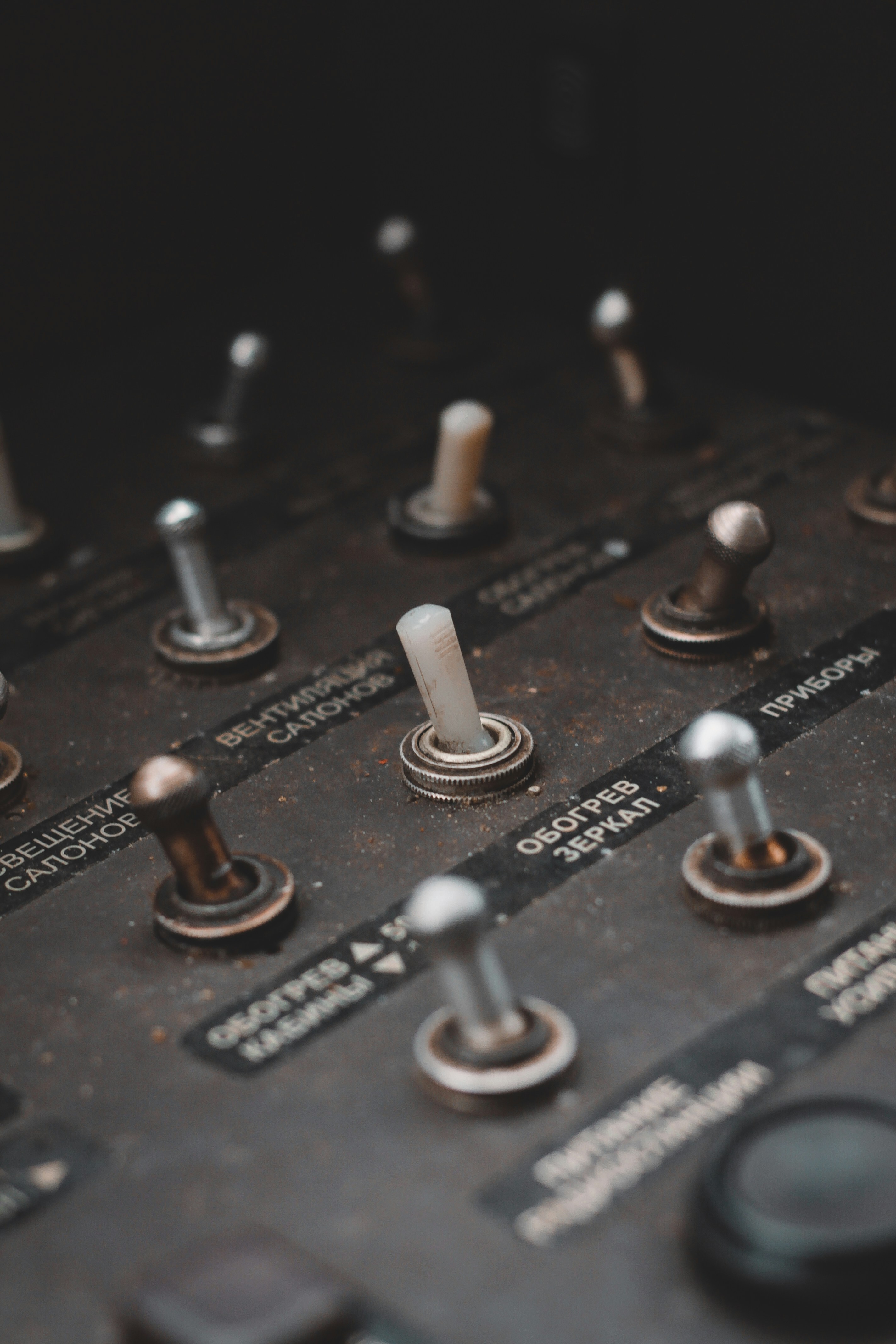 White Toggle in a Field of Dials: a close-up on a weathered control panel