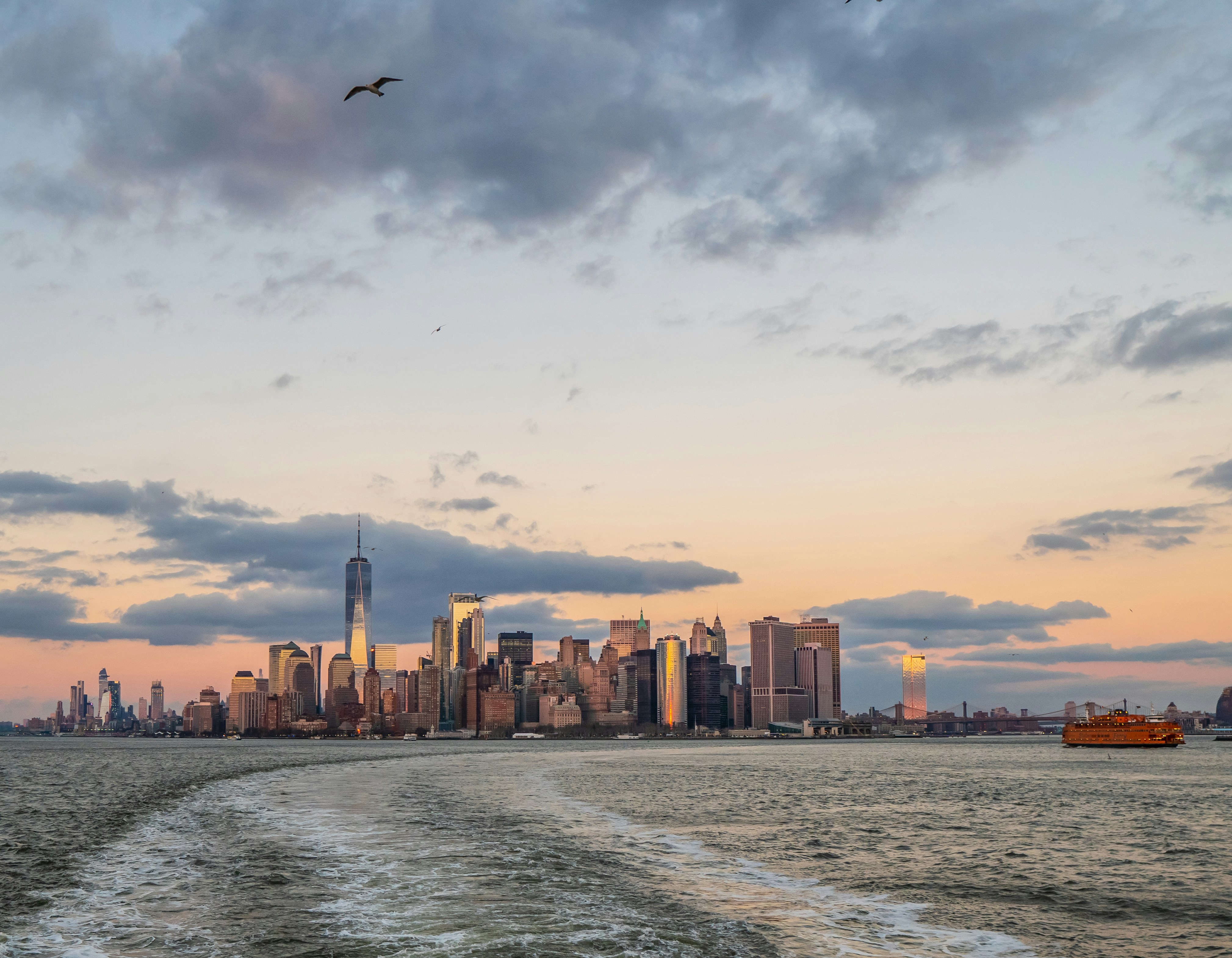 Sunset Over the Skyline: Coastal Wake to a Distant City