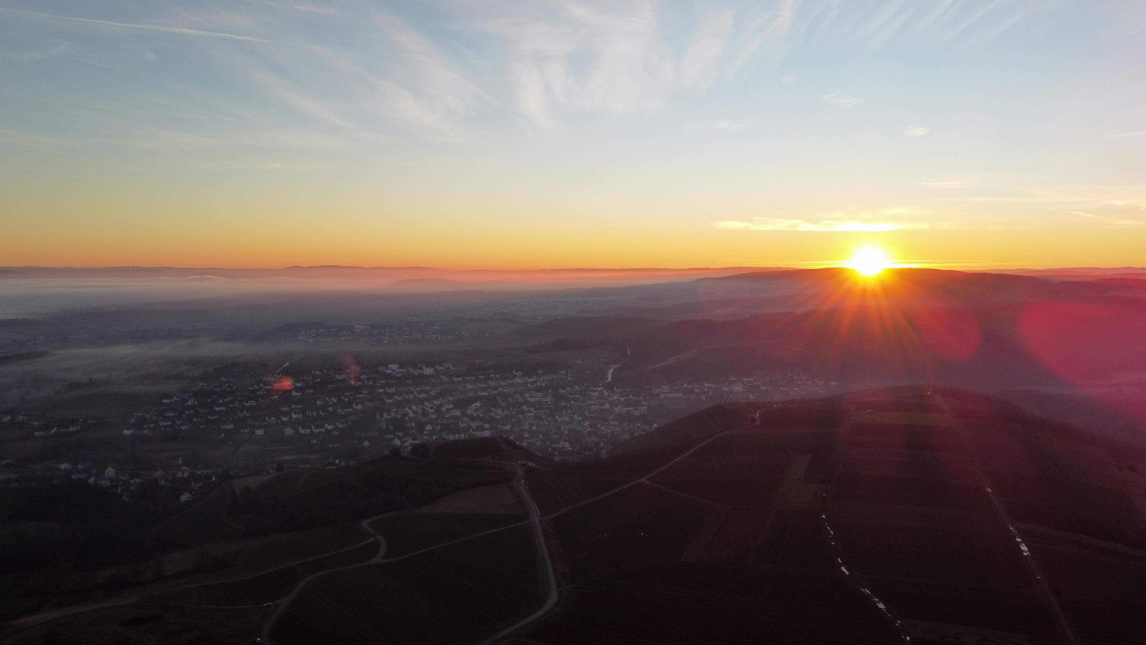 Sunrise Over Rolling Hills: A Quiet Horizon from Above