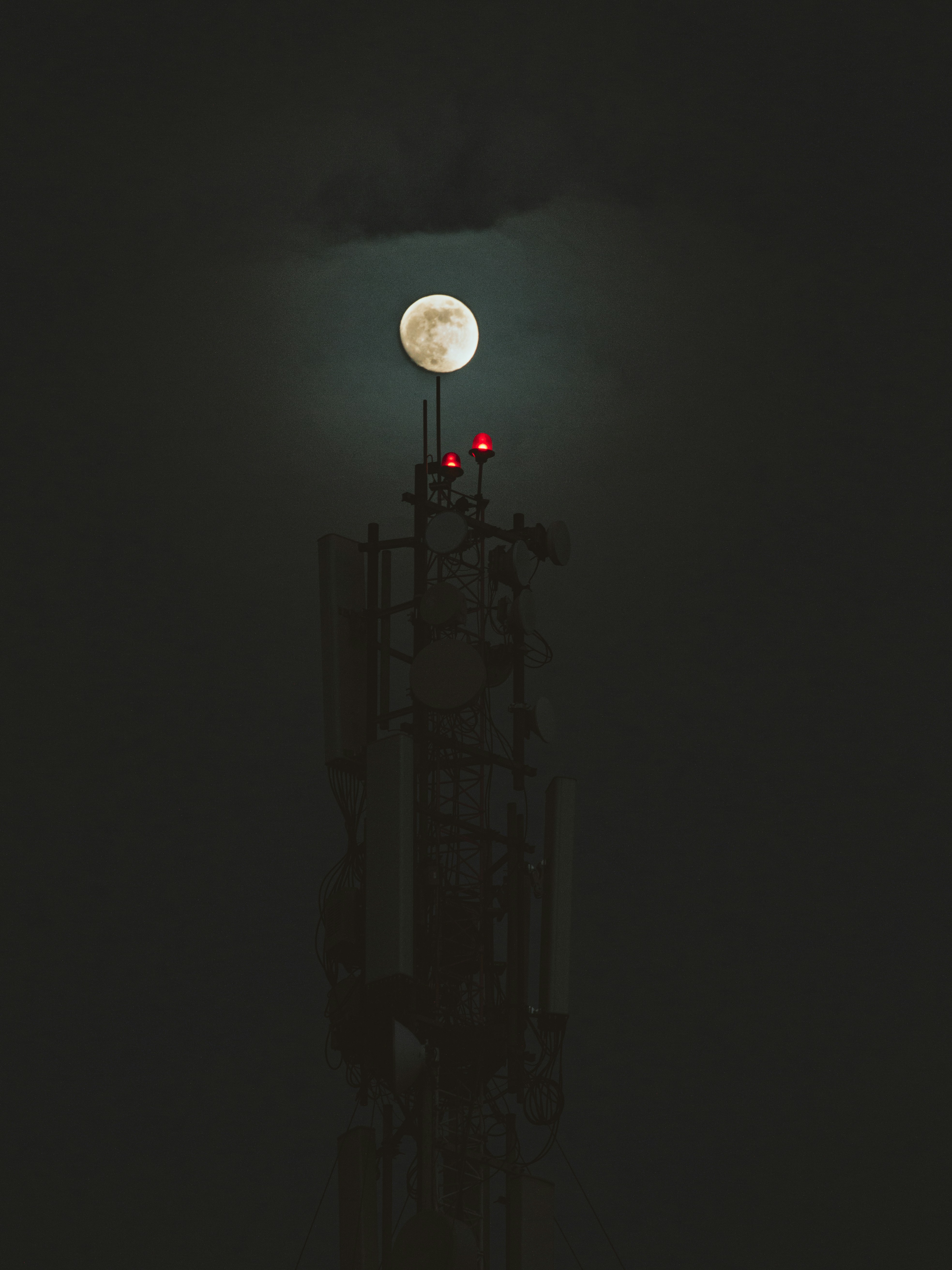 A cell tower with a full moon in the background photo – Free Moon Image ...