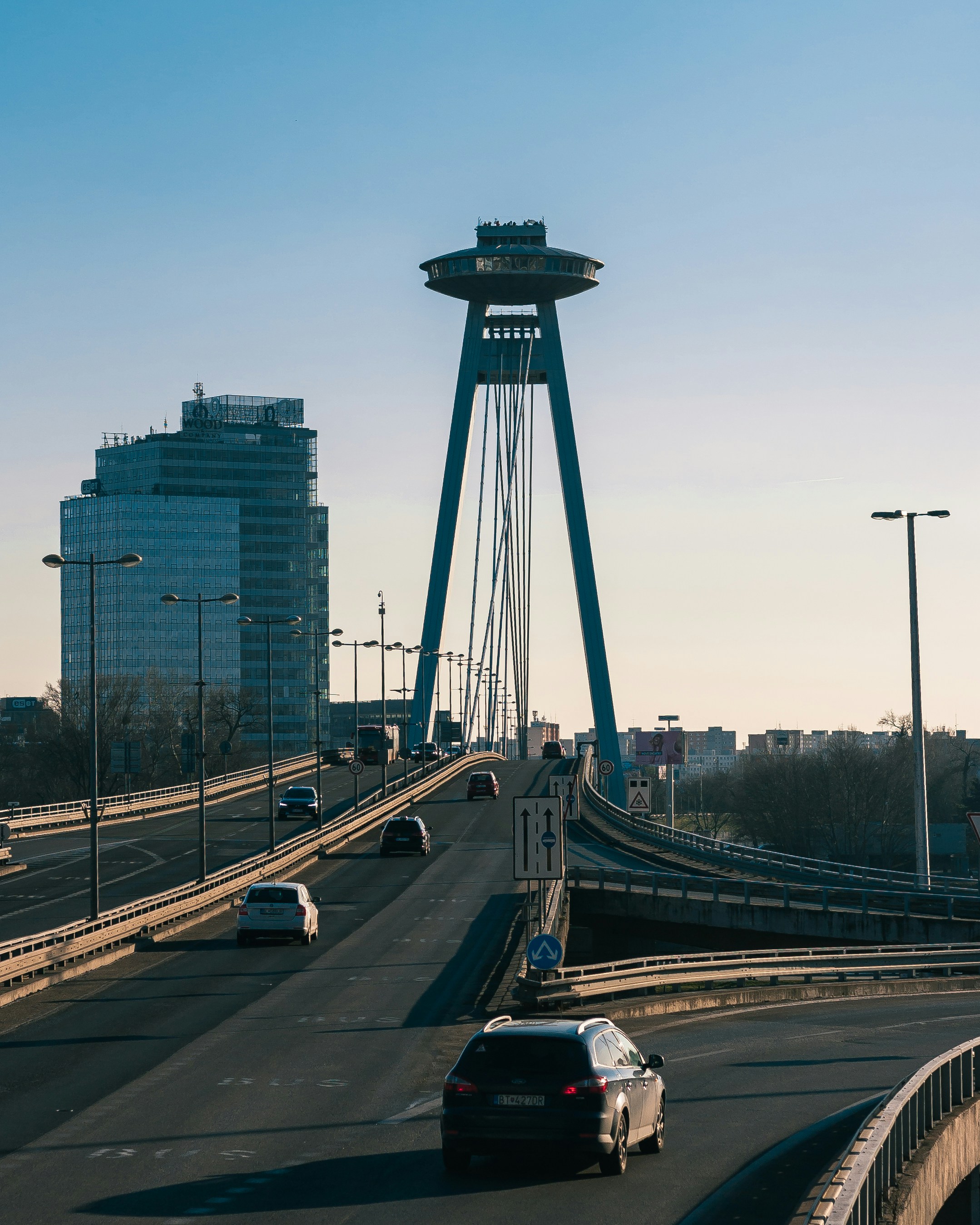 The Aerial Gate: Center Tower Framing a Moving City