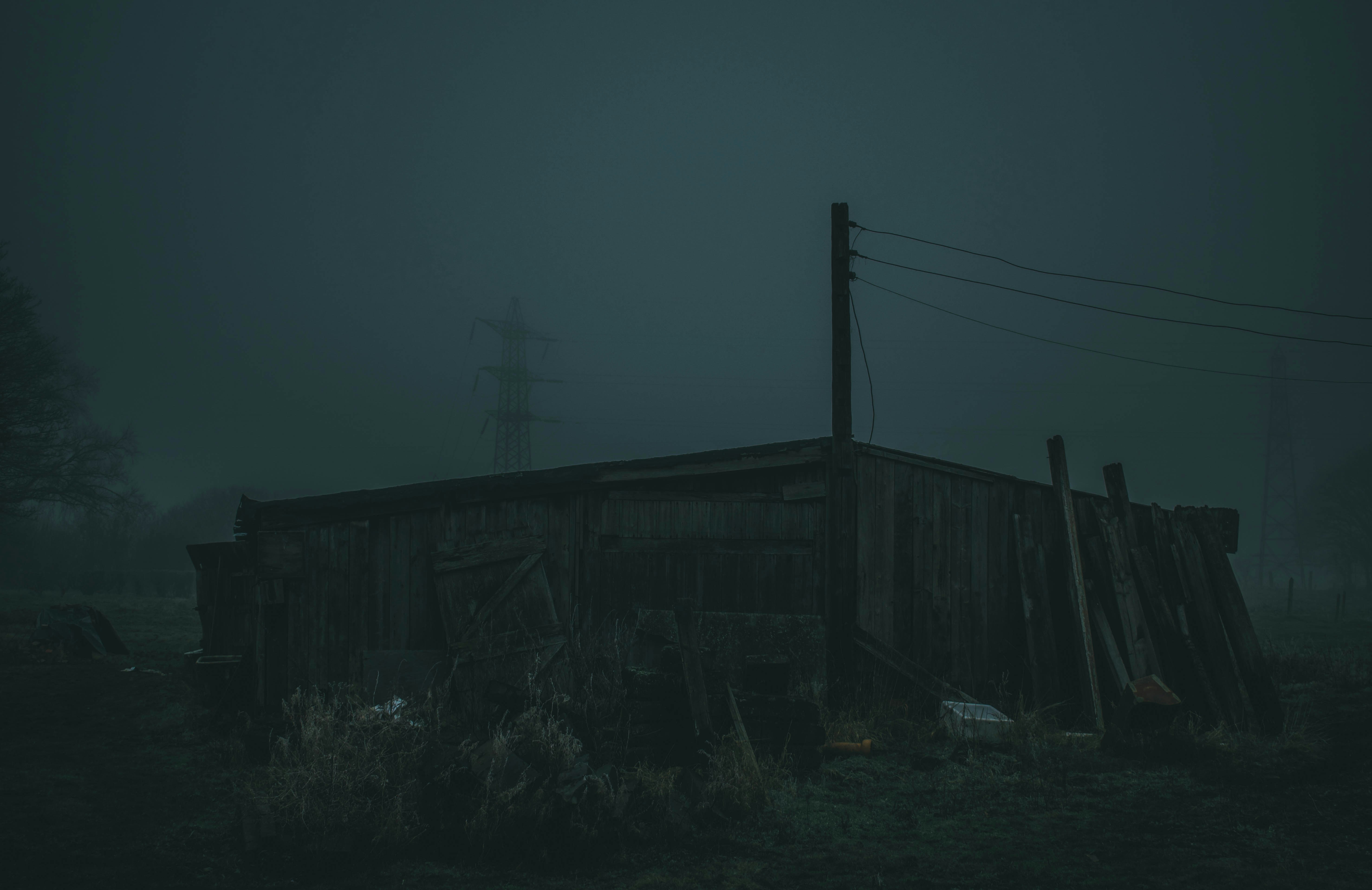 An old shack sitting in a field on a foggy night photo – Free Fog Image ...