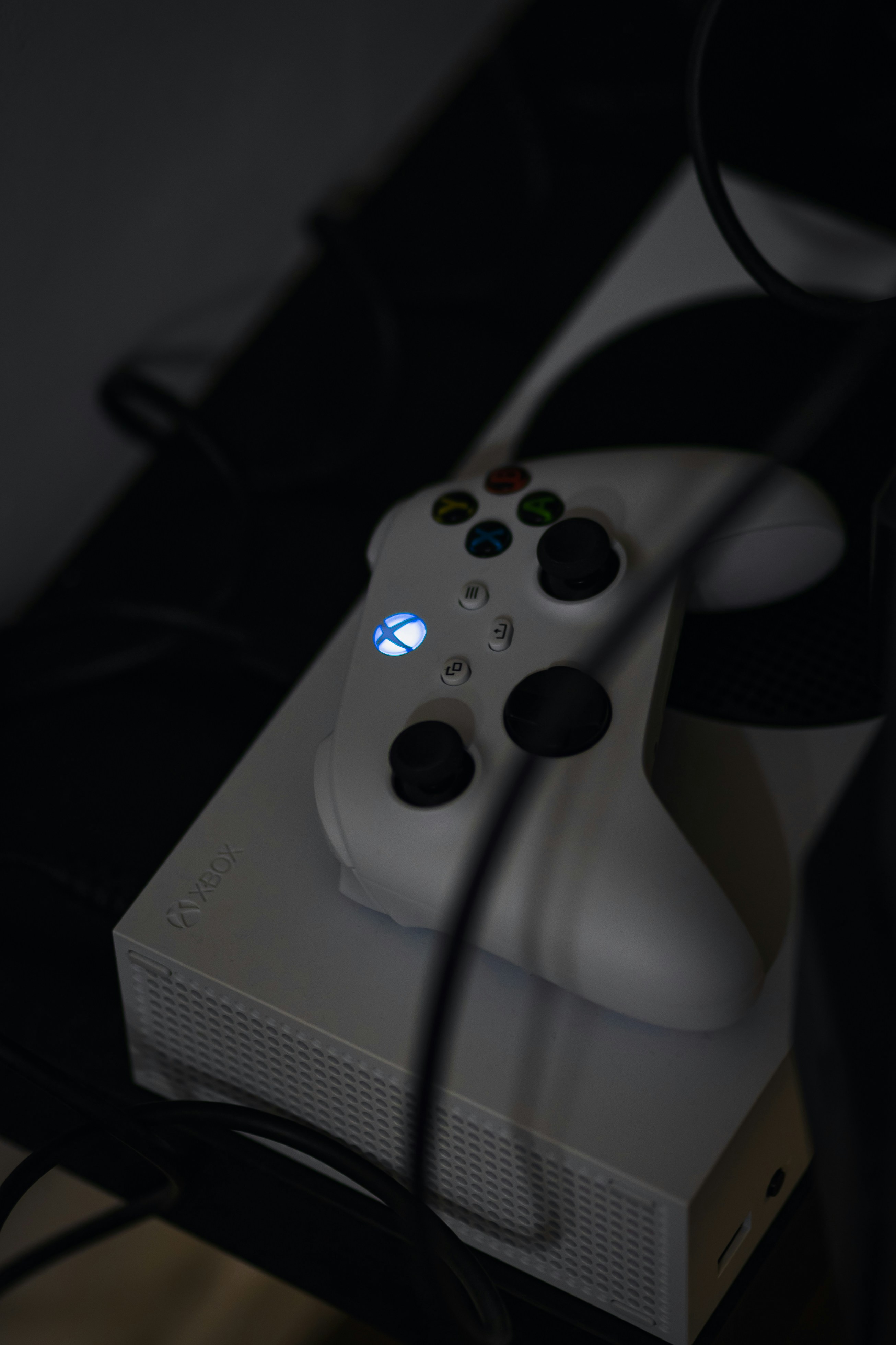 A video game controller sitting on top of a table photo – Free Grey ...