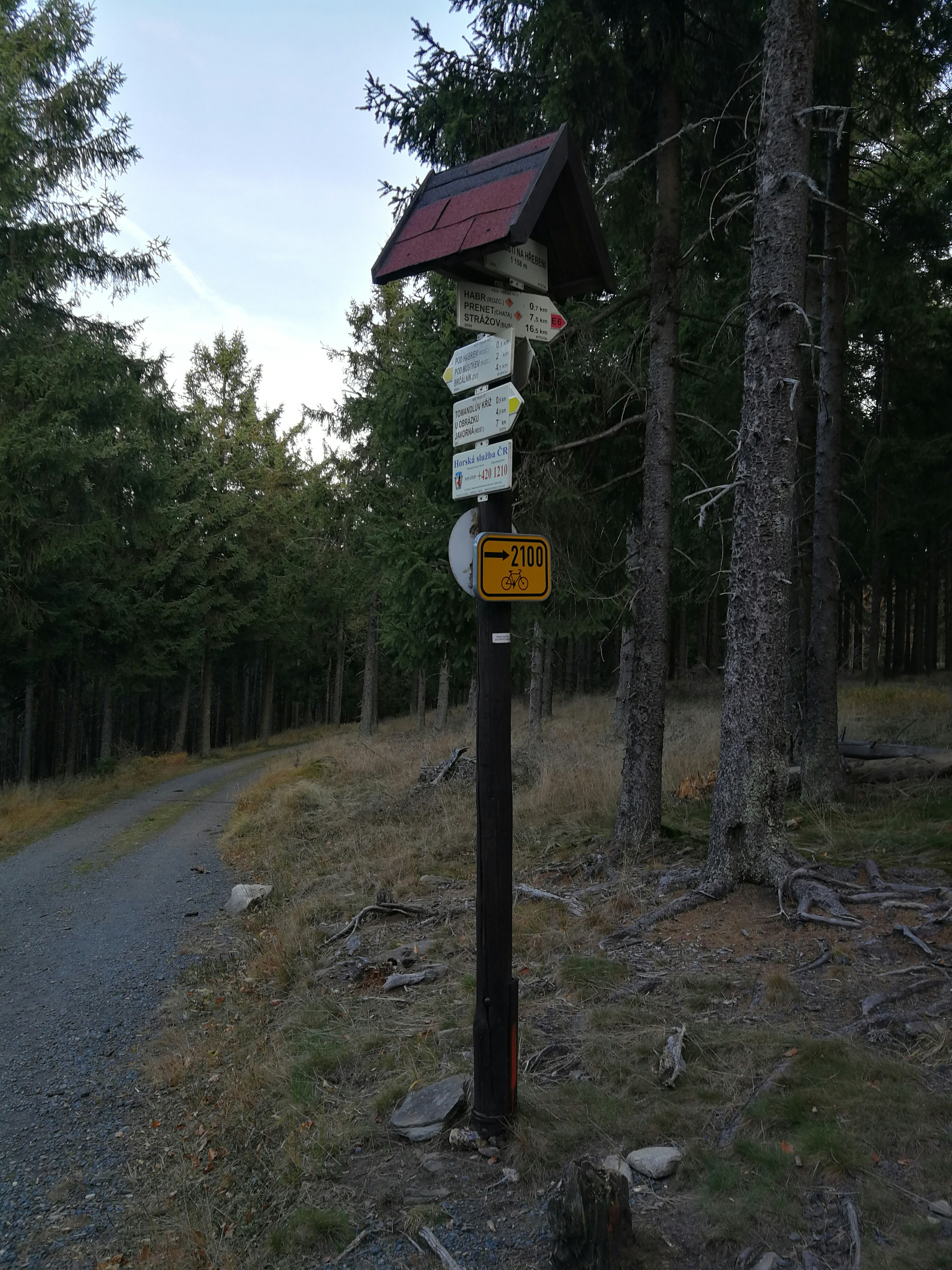 a wooden post with a mailbox on top of it