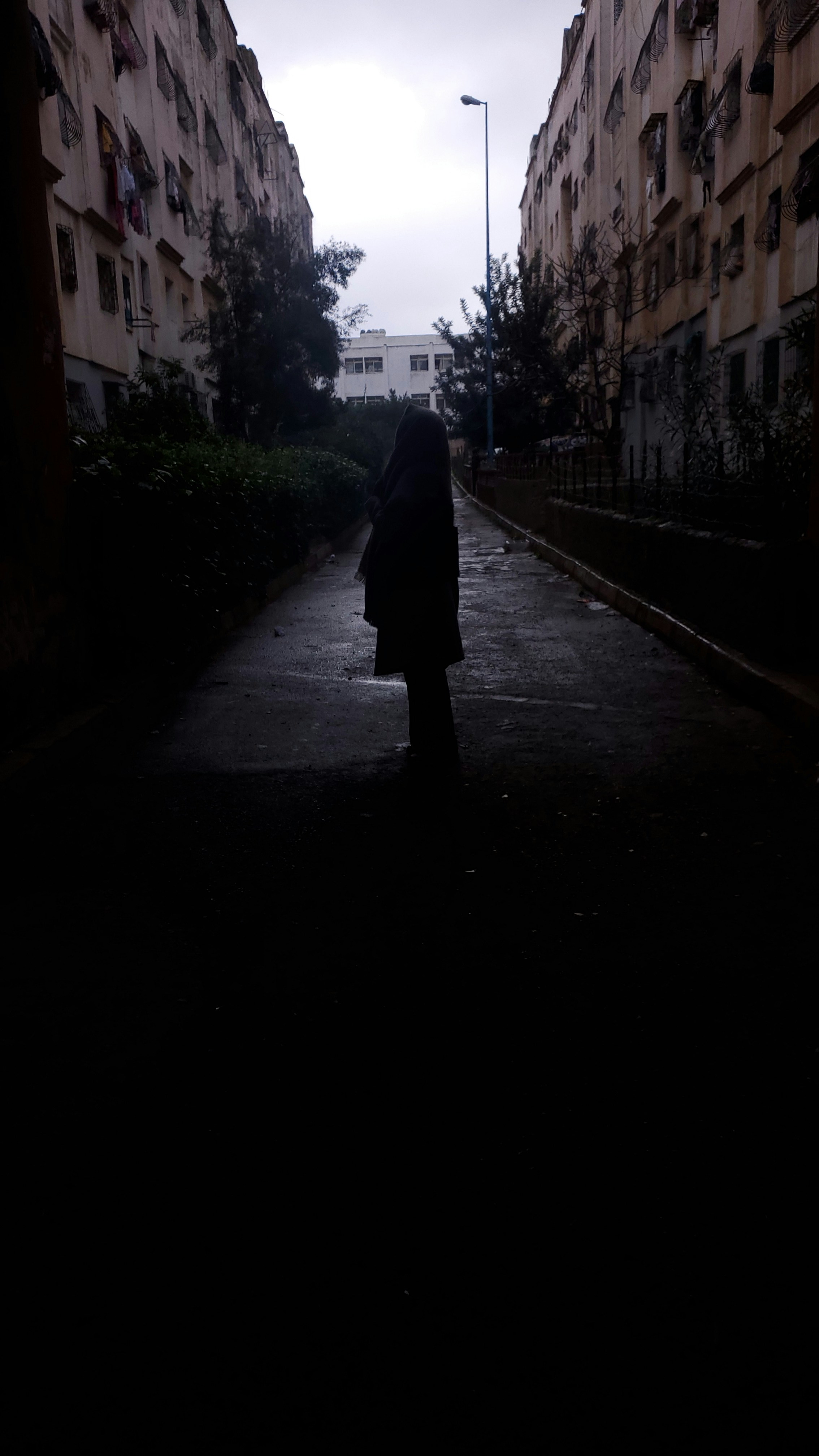 A person walking down a street in the dark photo – Free Human Image on ...