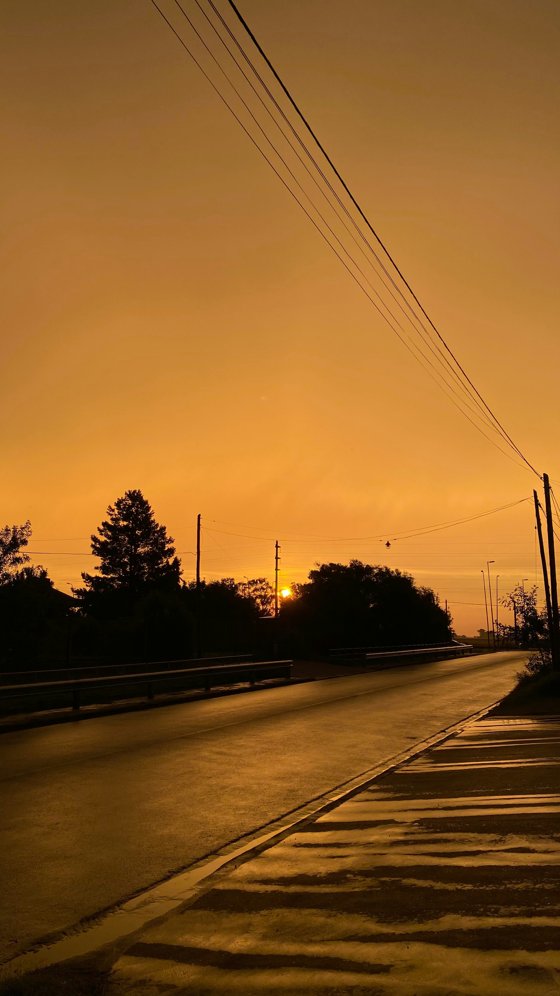Tangerine Twilight Along a Quiet Street with Power Lines