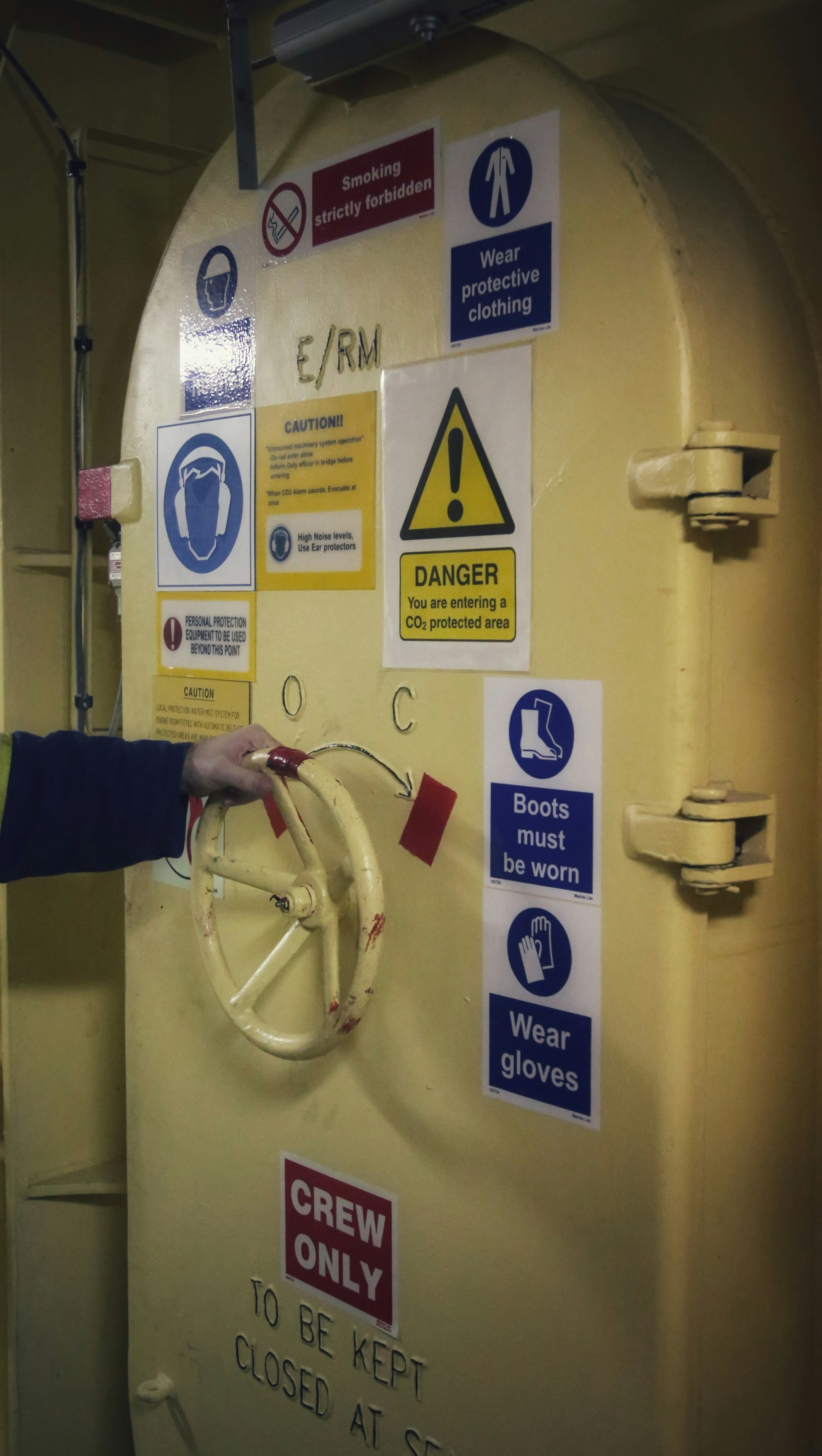 Door with warning signs on a container vessel.