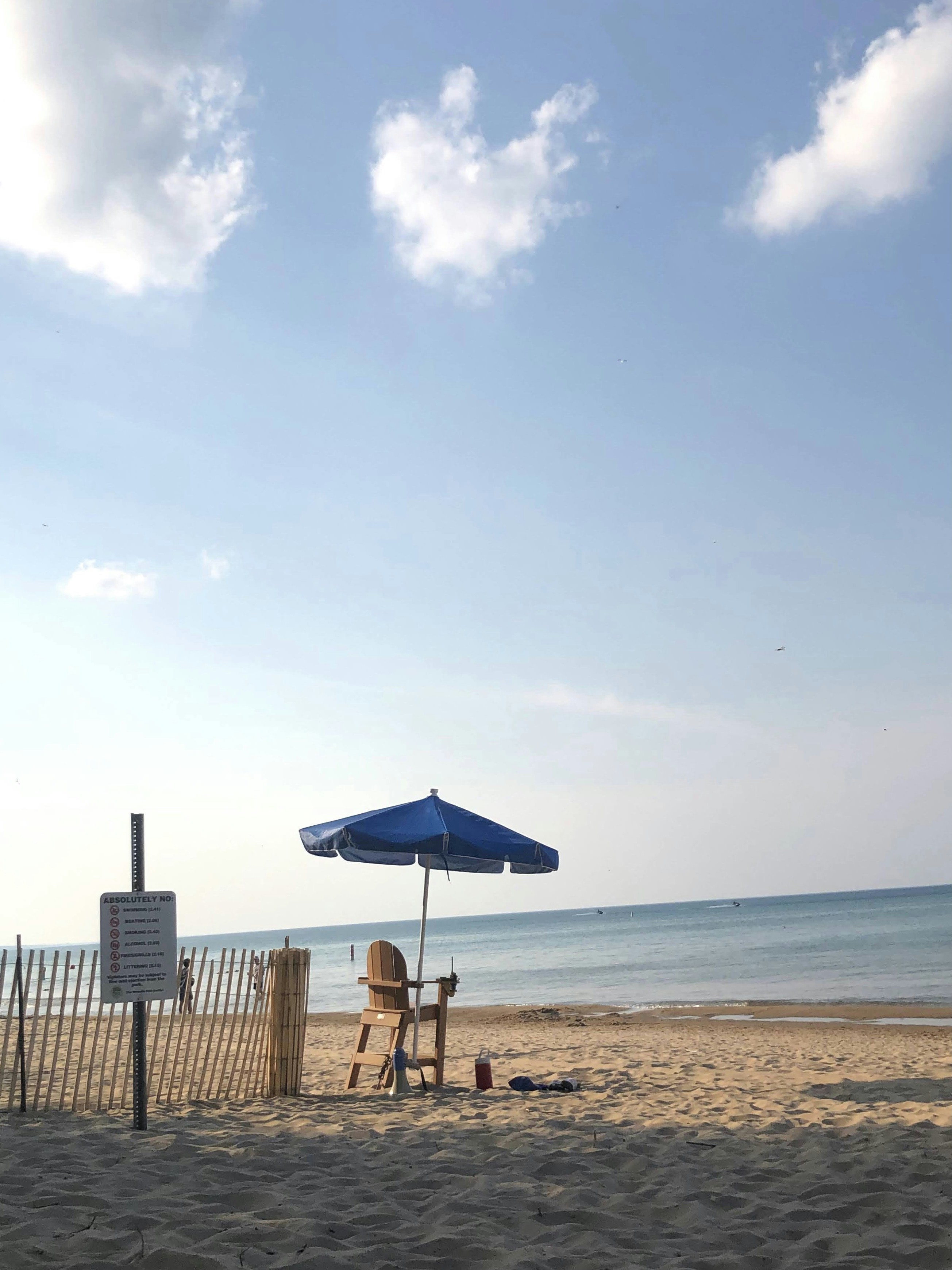 A beach with a blue umbrella and a chair photo – Free Asthetic Image on ...
