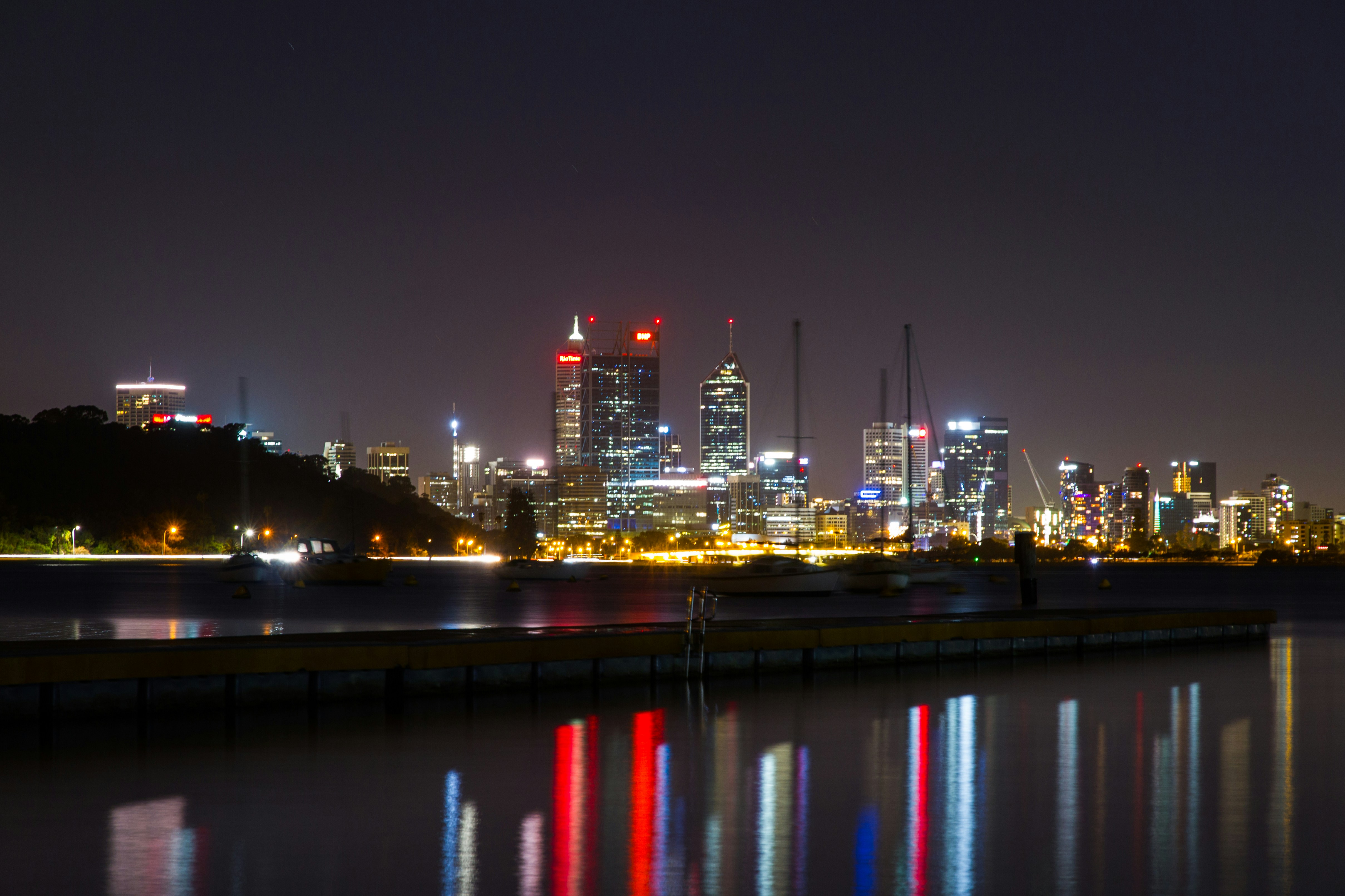 A city skyline is lit up at night photo – Free Perth city Image on Unsplash