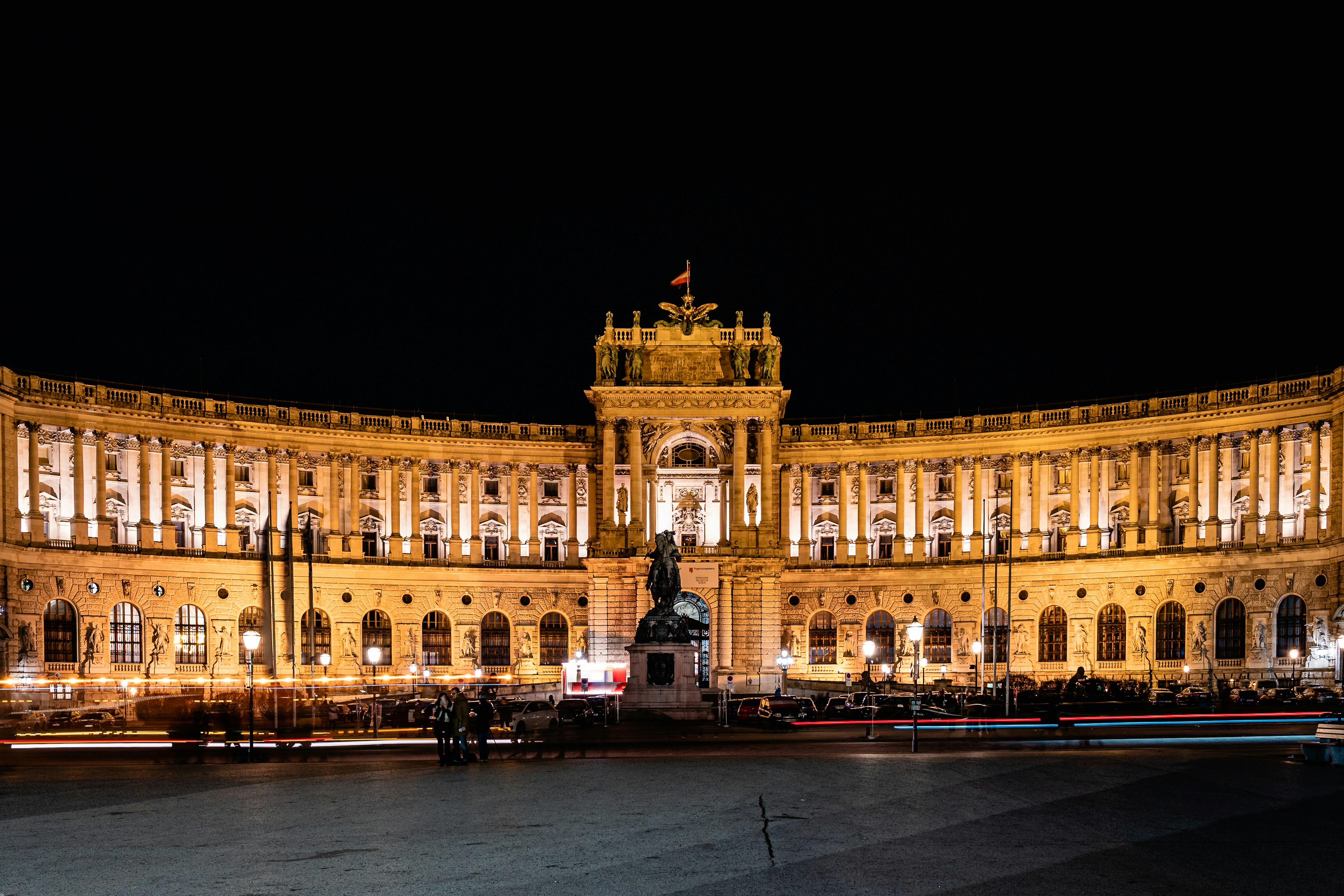 Amber Arc at Night: Central Monument Framed by Warm Colonnades