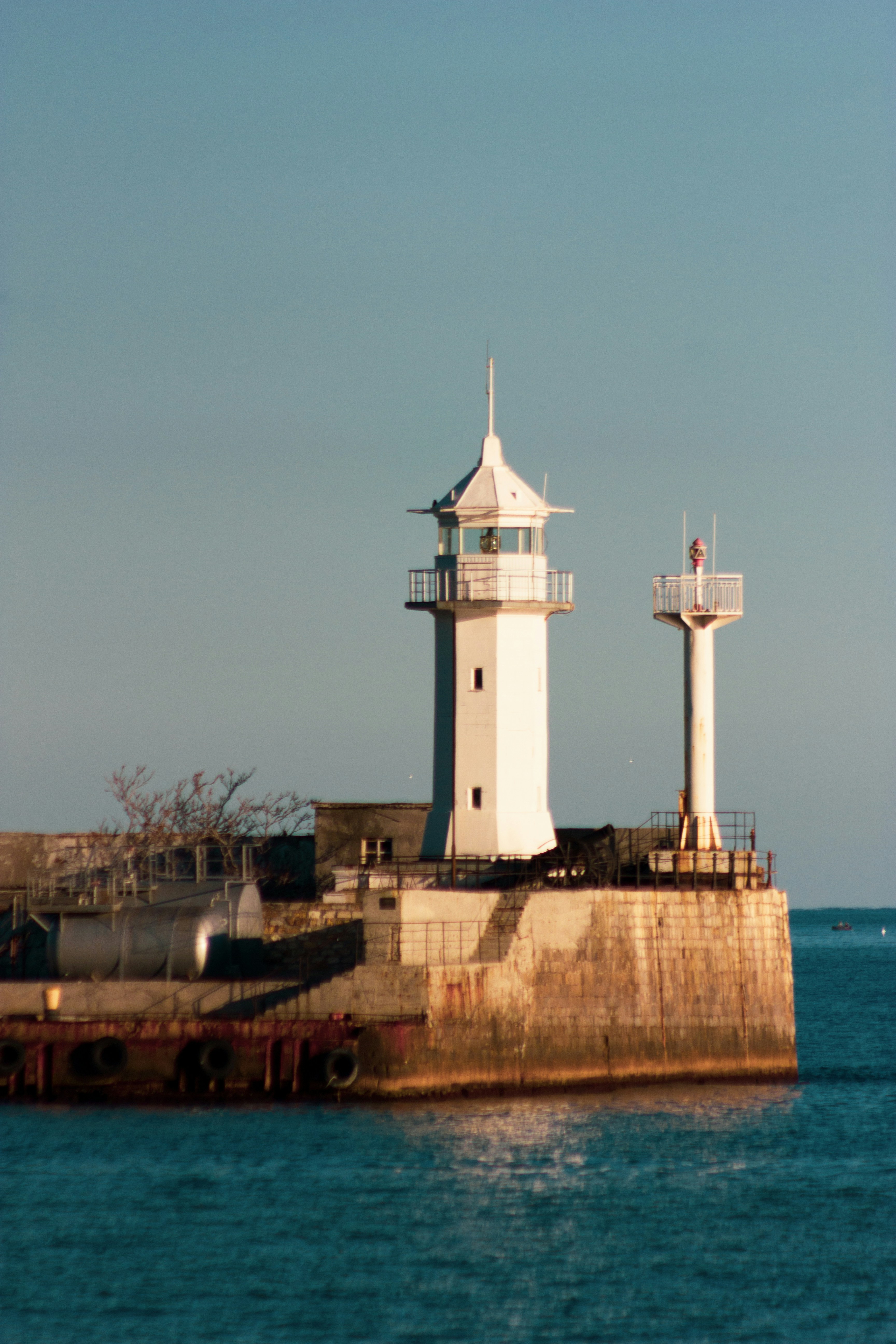 A couple of lighthouses sitting on top of a pier photo – Free ...