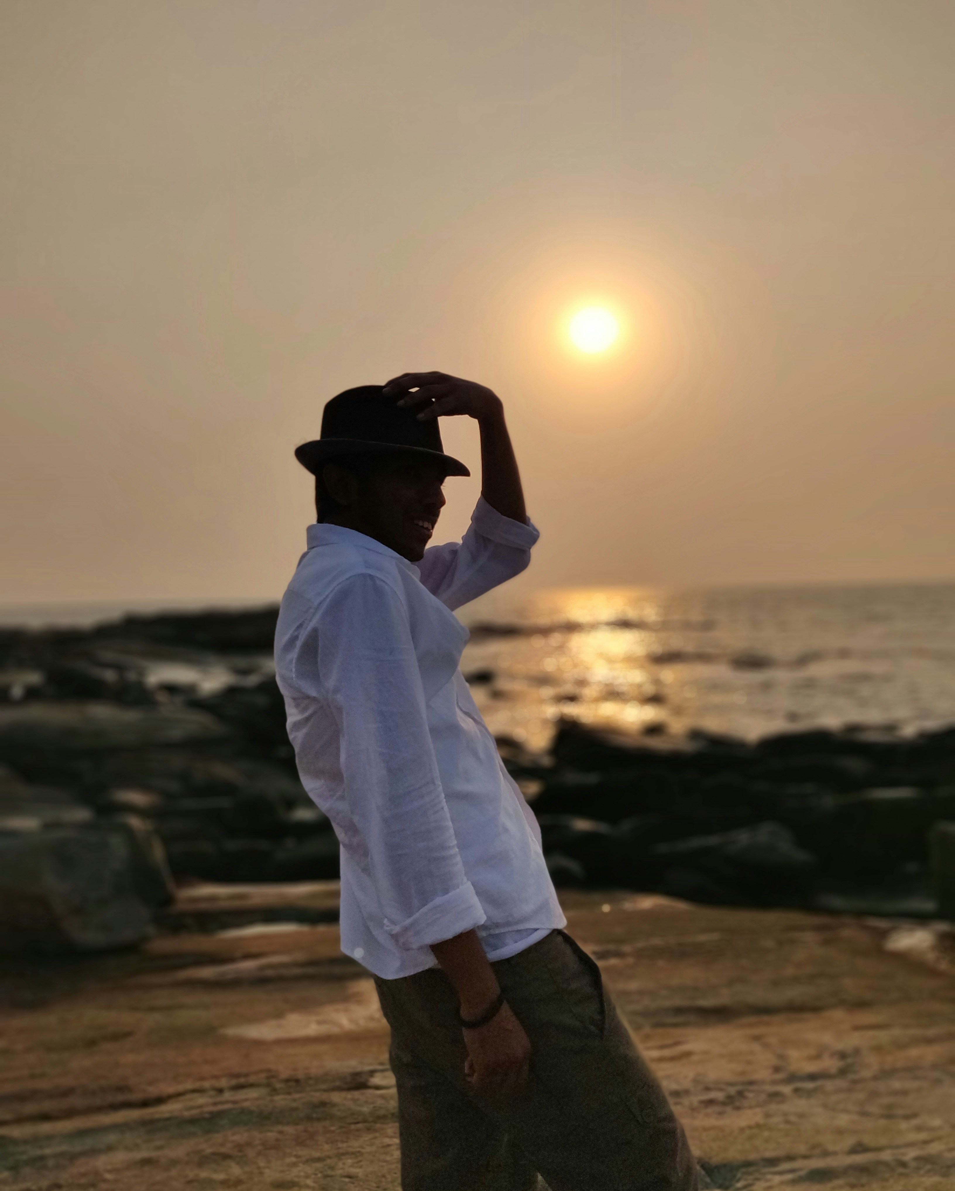 Silhouette at Sunset: A Gentle Gesture on the Shore