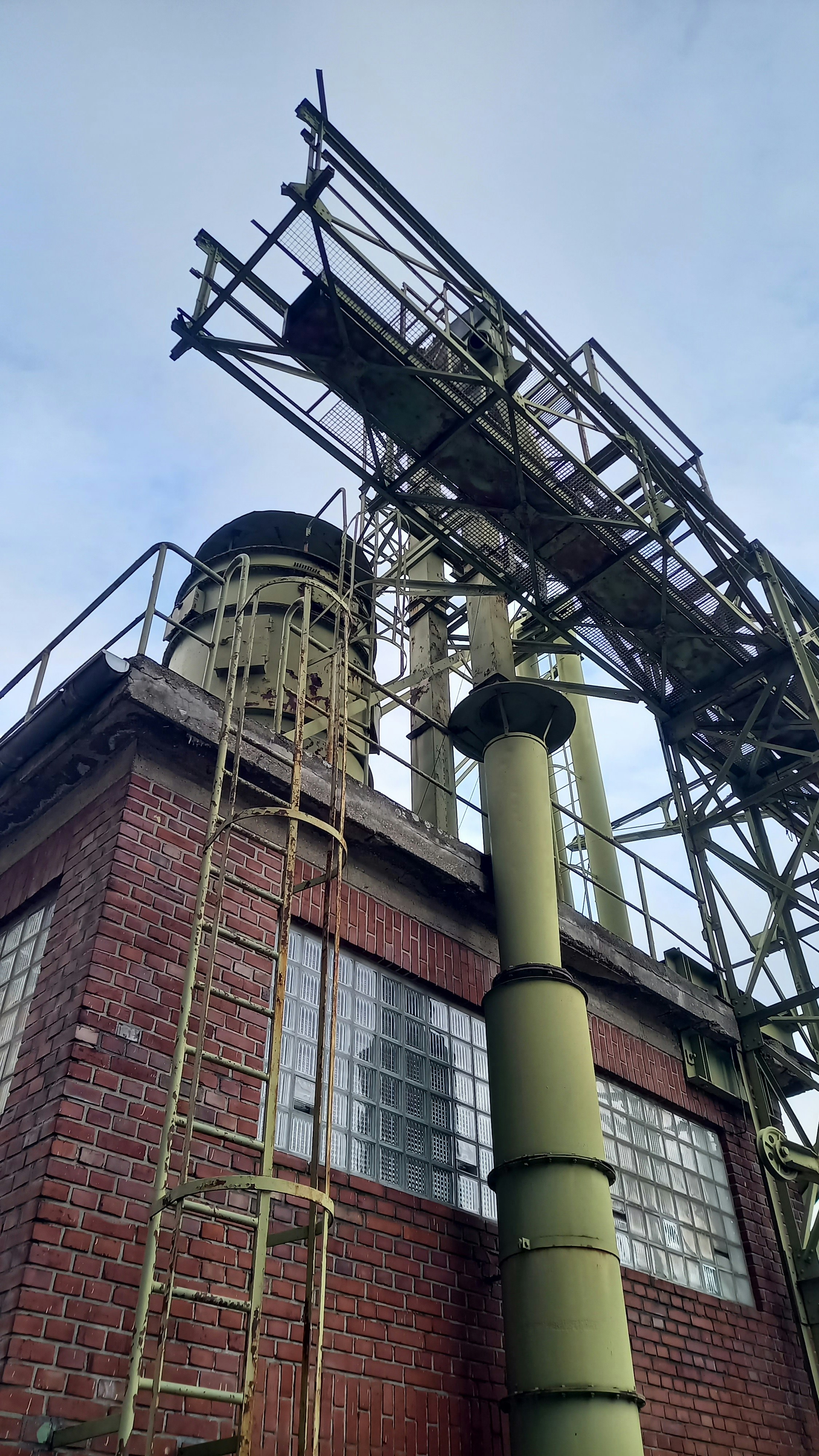 Skyward Lattice: Weathered Steel and Brick in an Industrial Landscape