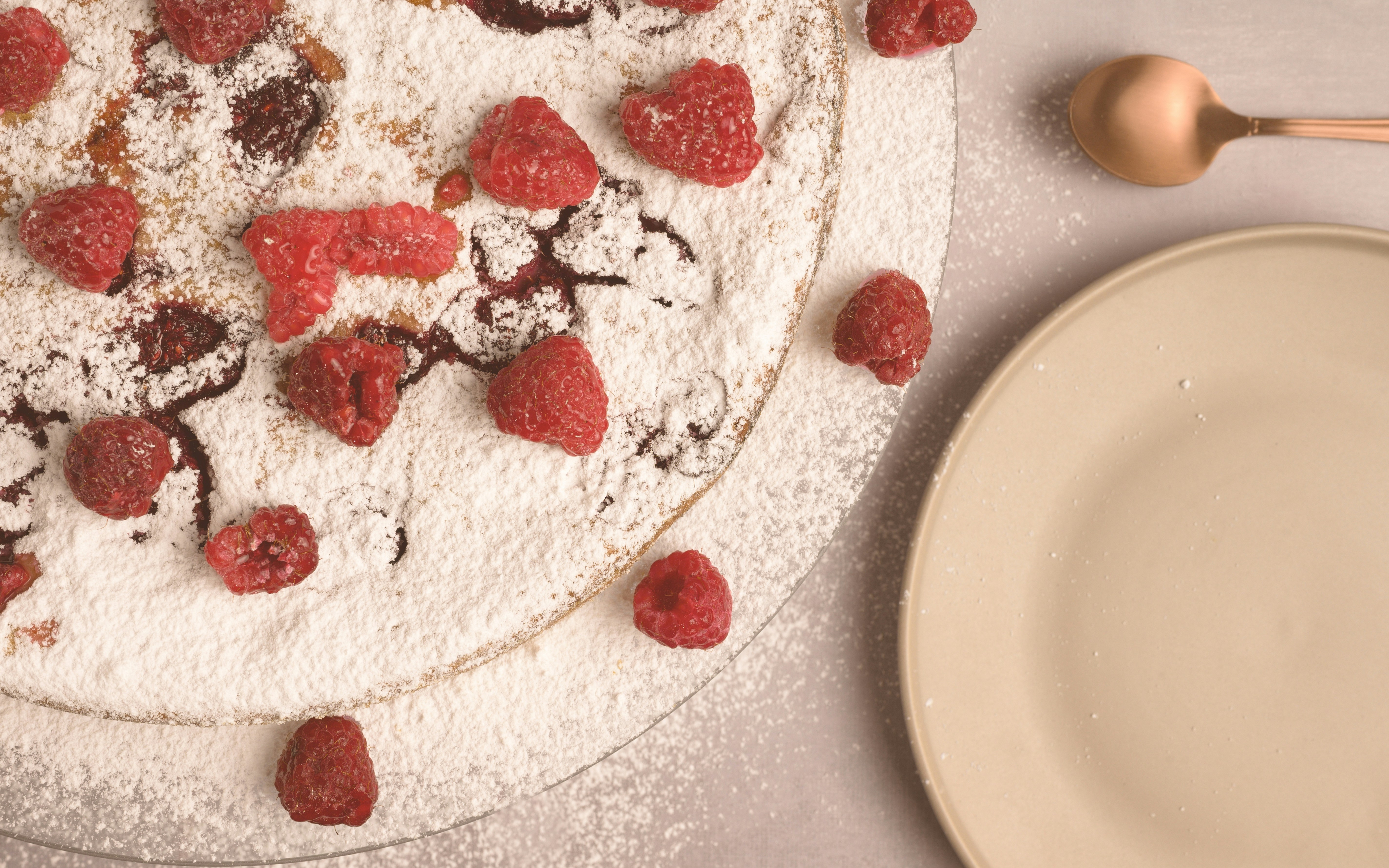 Raspberry Crowned Cake: Powdered-Sugar Snow Under Subtle Studio Light