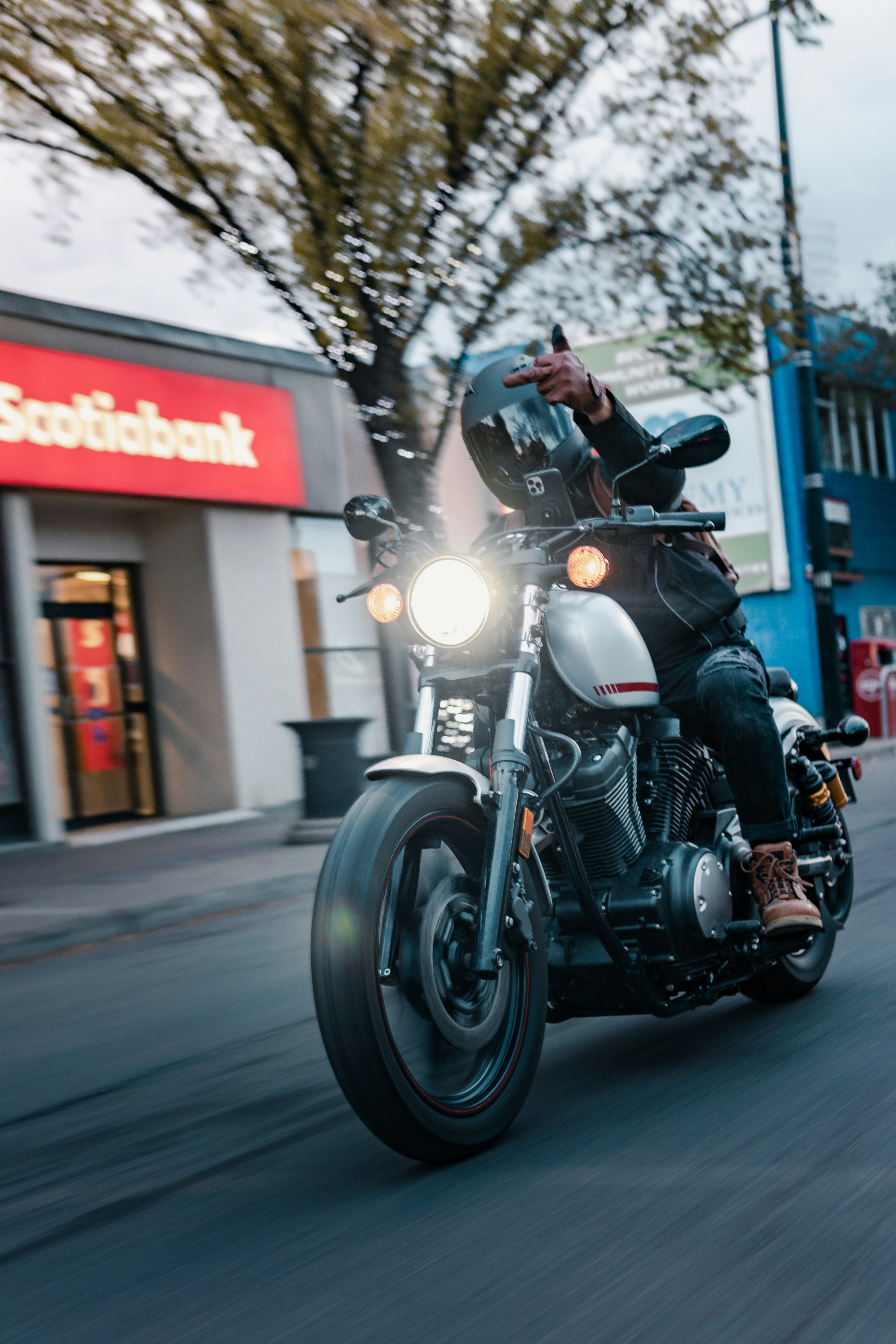 City Chrome in Motion: Rider Blurs Past a Downtown Bank