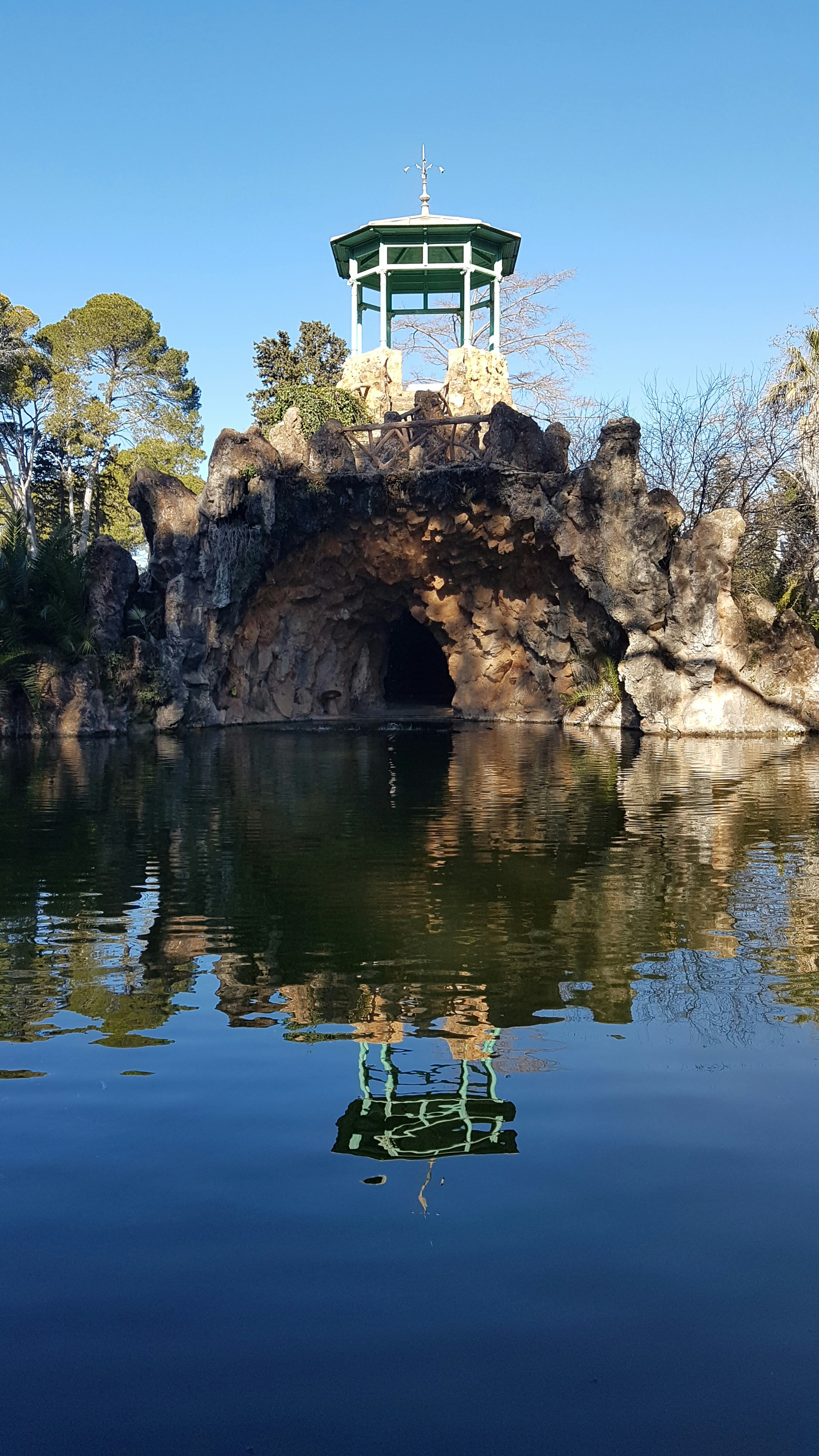 Gazebo on the Rock Gate Over a Reflective Lake
