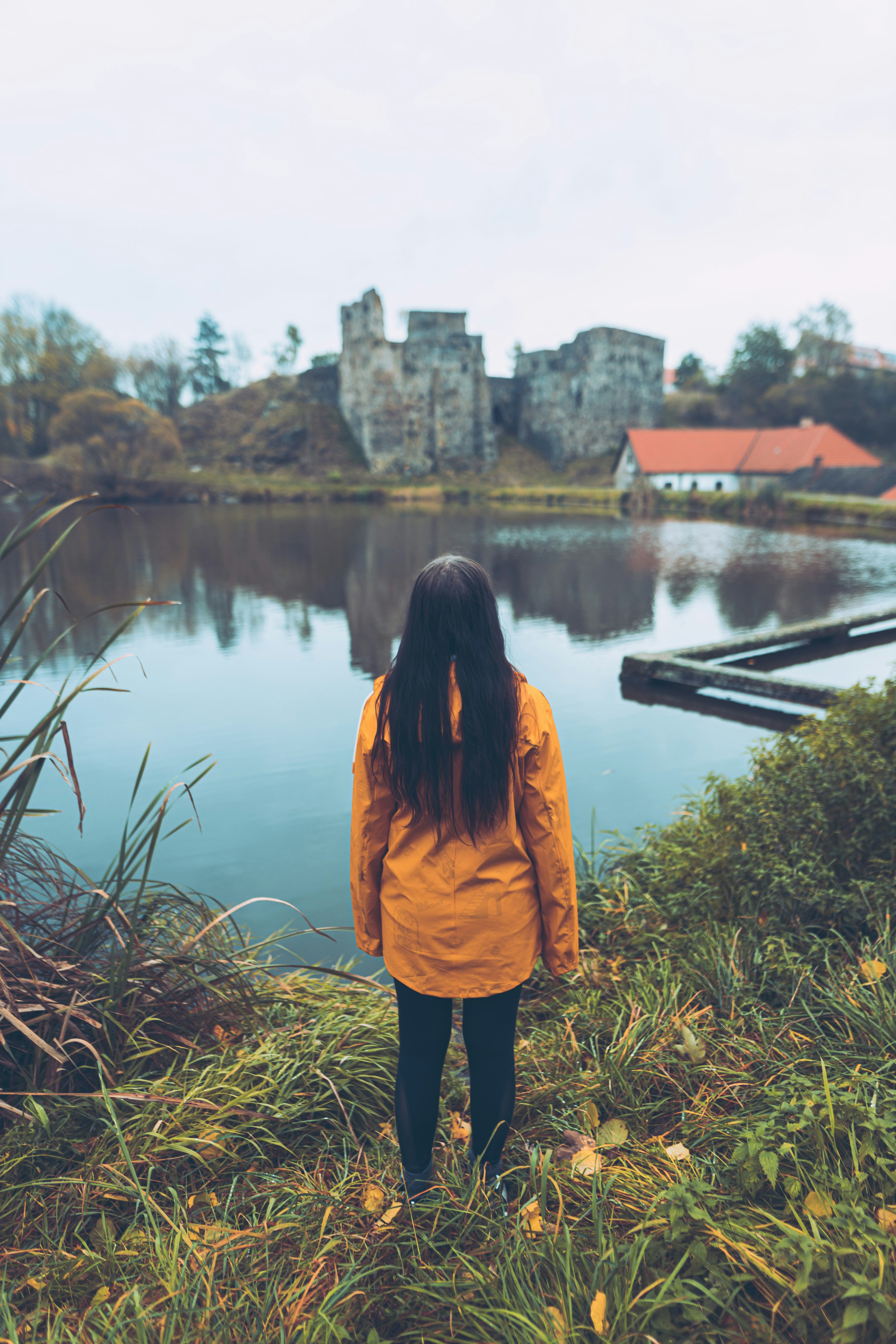 Amber-clad Silhouette by a Quiet Lake with Ancient Ruins