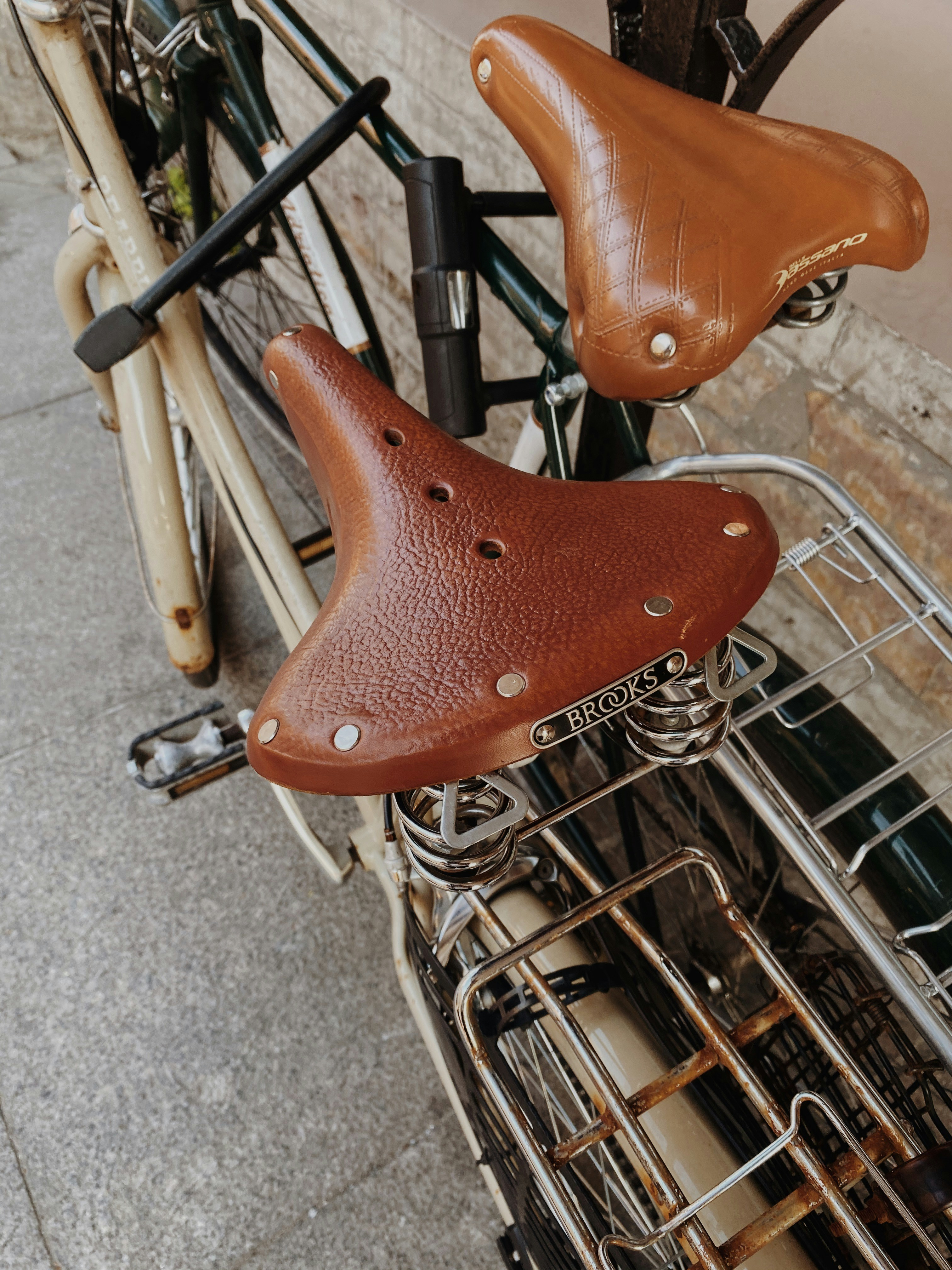 a close up of a bicycle with a brown seat
