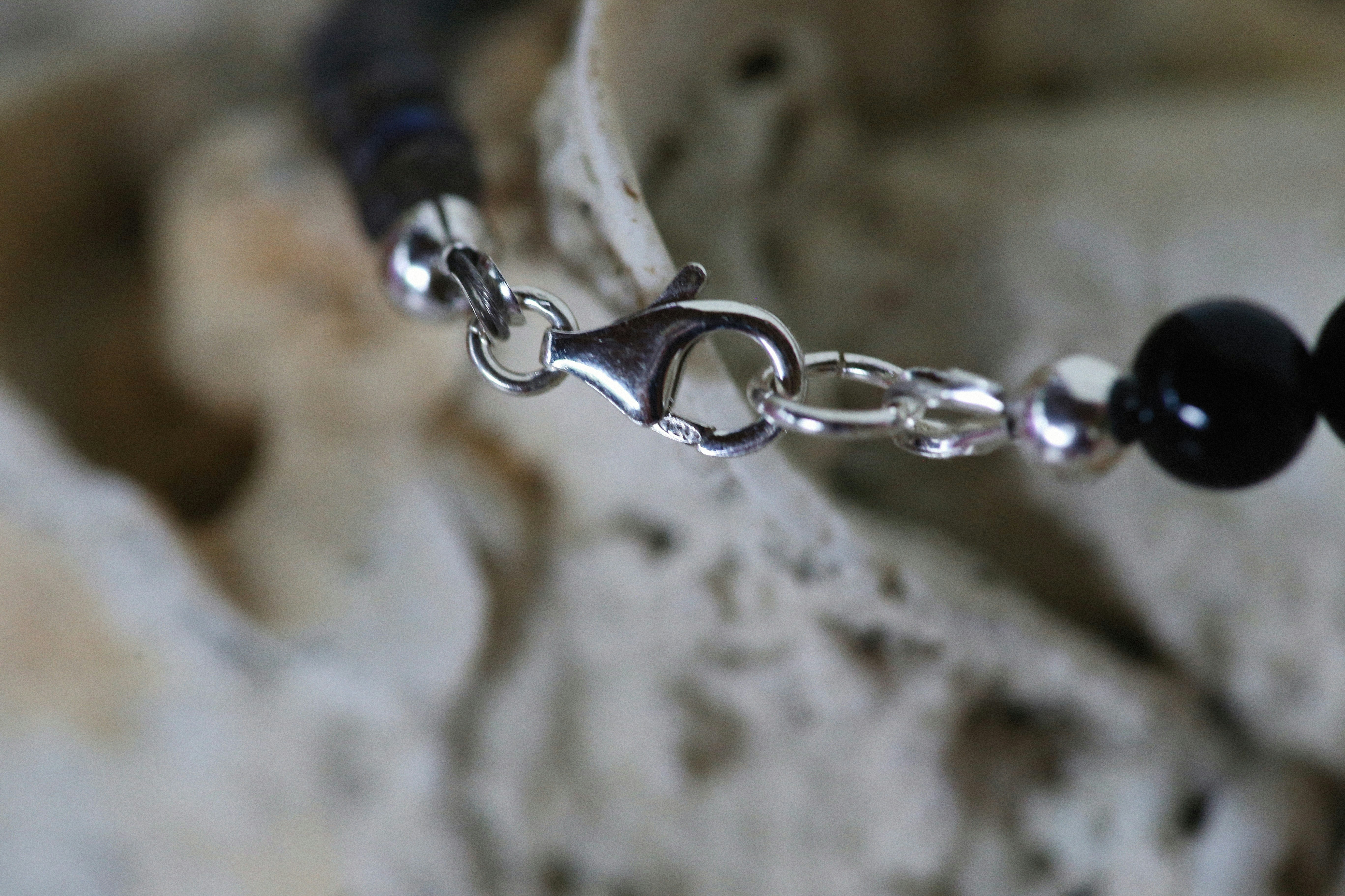 Clasp in Macro: a precise study of metal links against stone texture