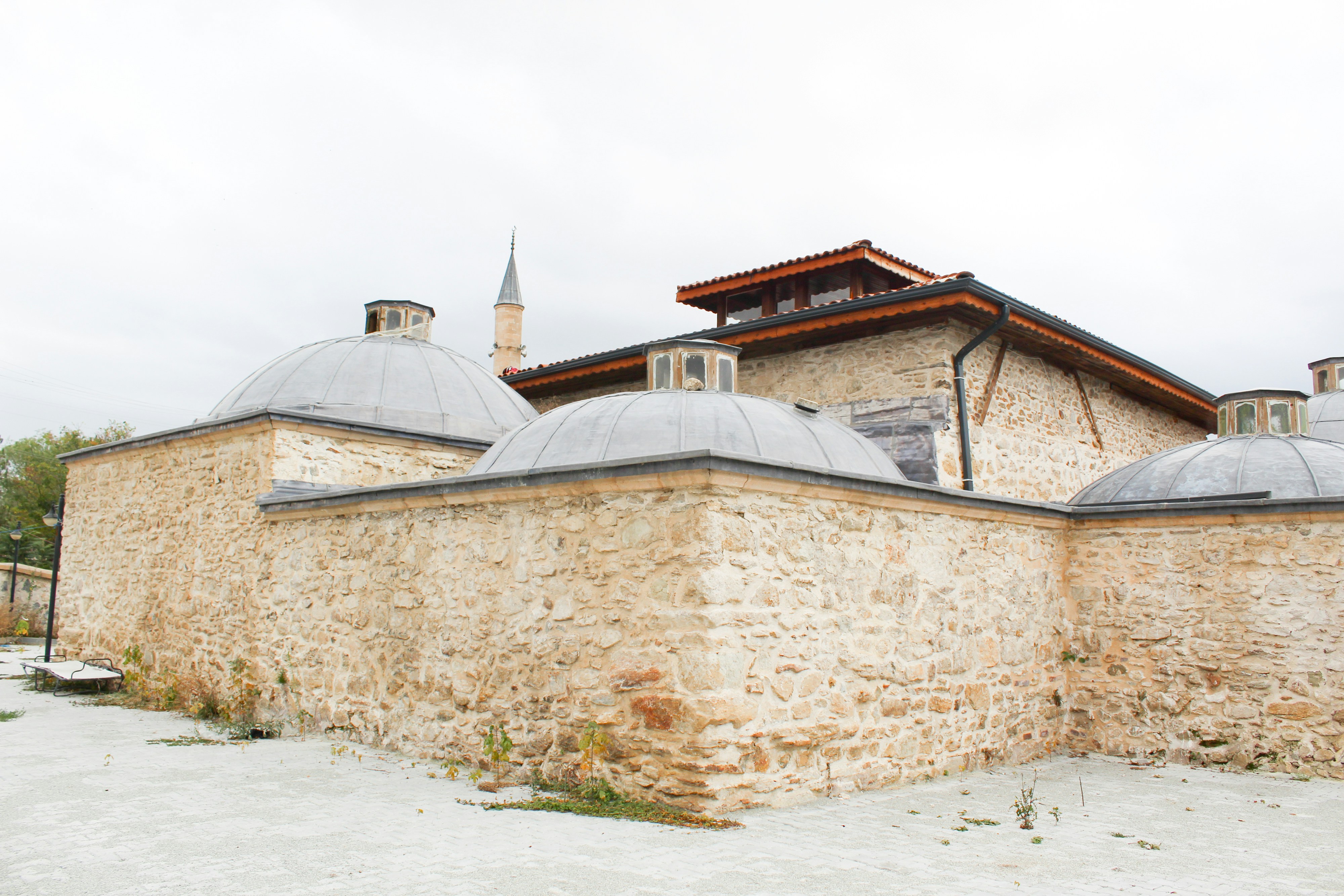 A building made of stone with two domes photo – Free Hamam Image on ...