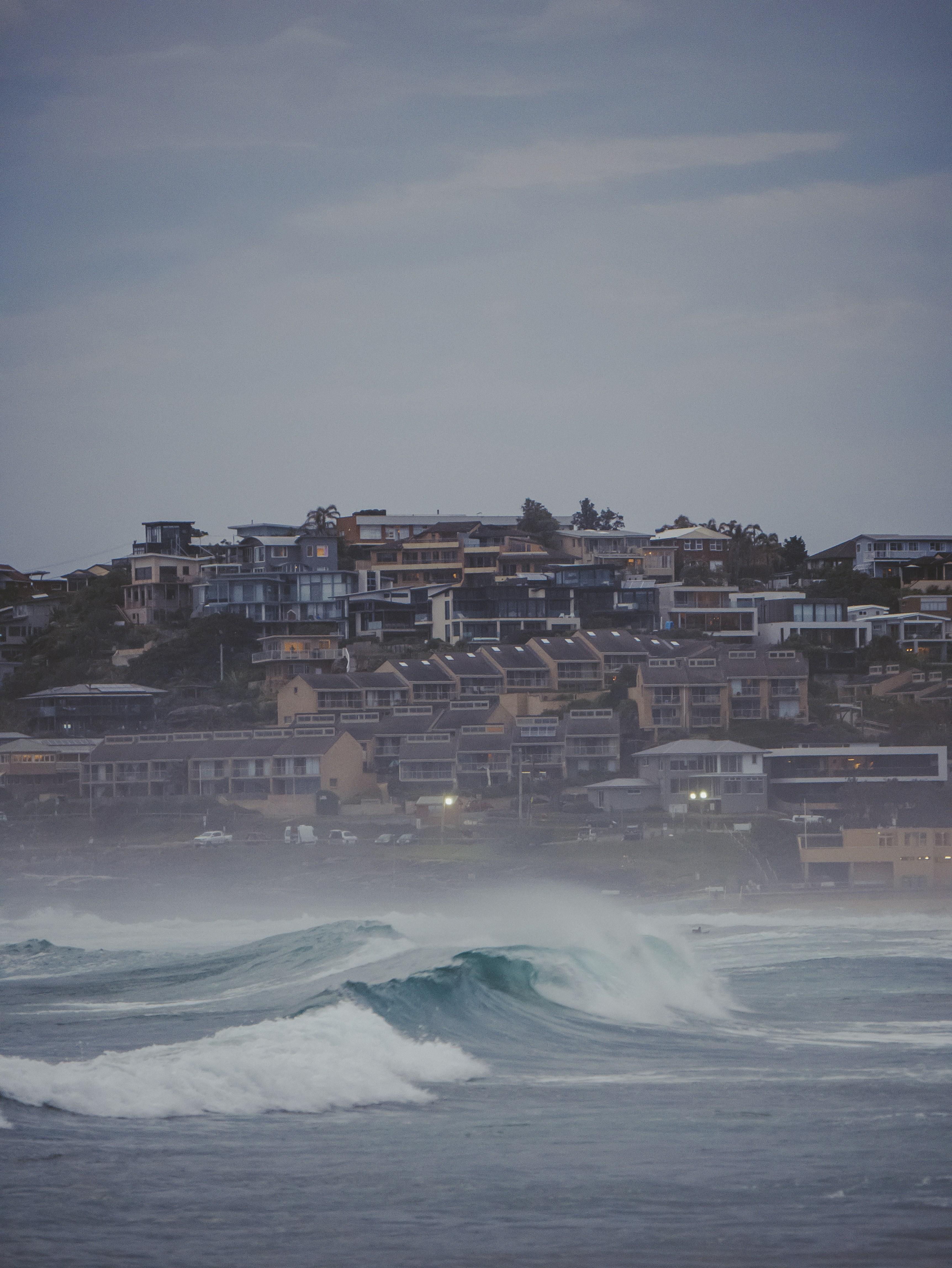 Coastal City Silhouette Beneath Rolling Surf