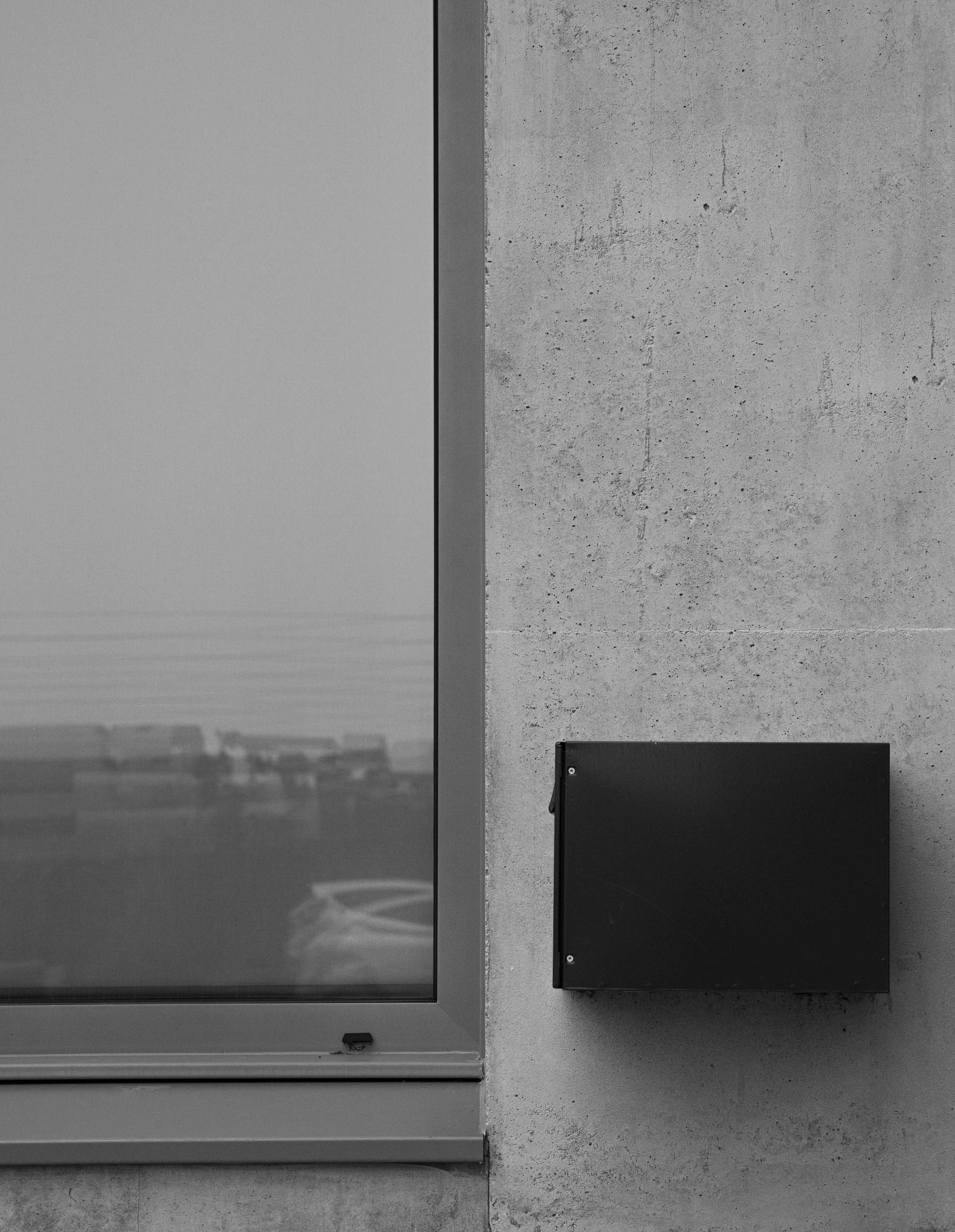 a wall mounted mailbox next to a window
