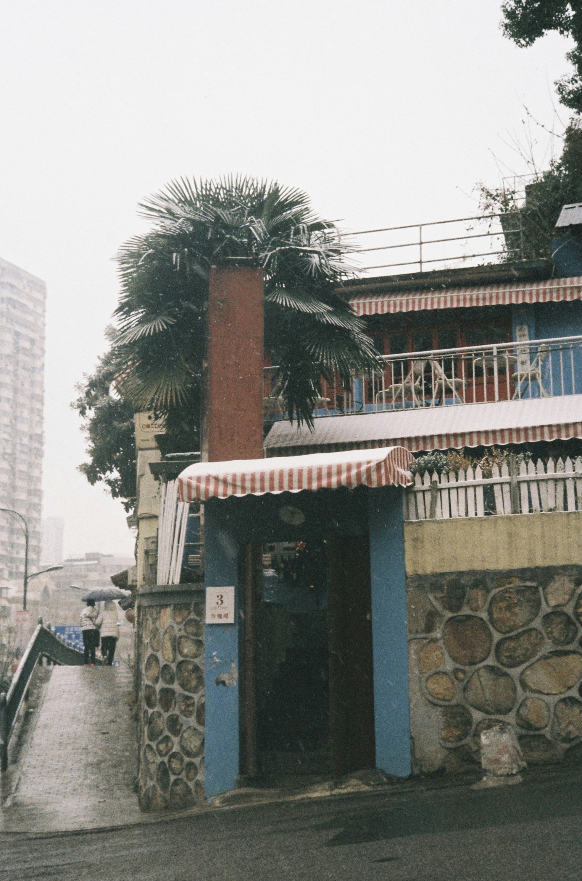 a building with a red and white striped awning