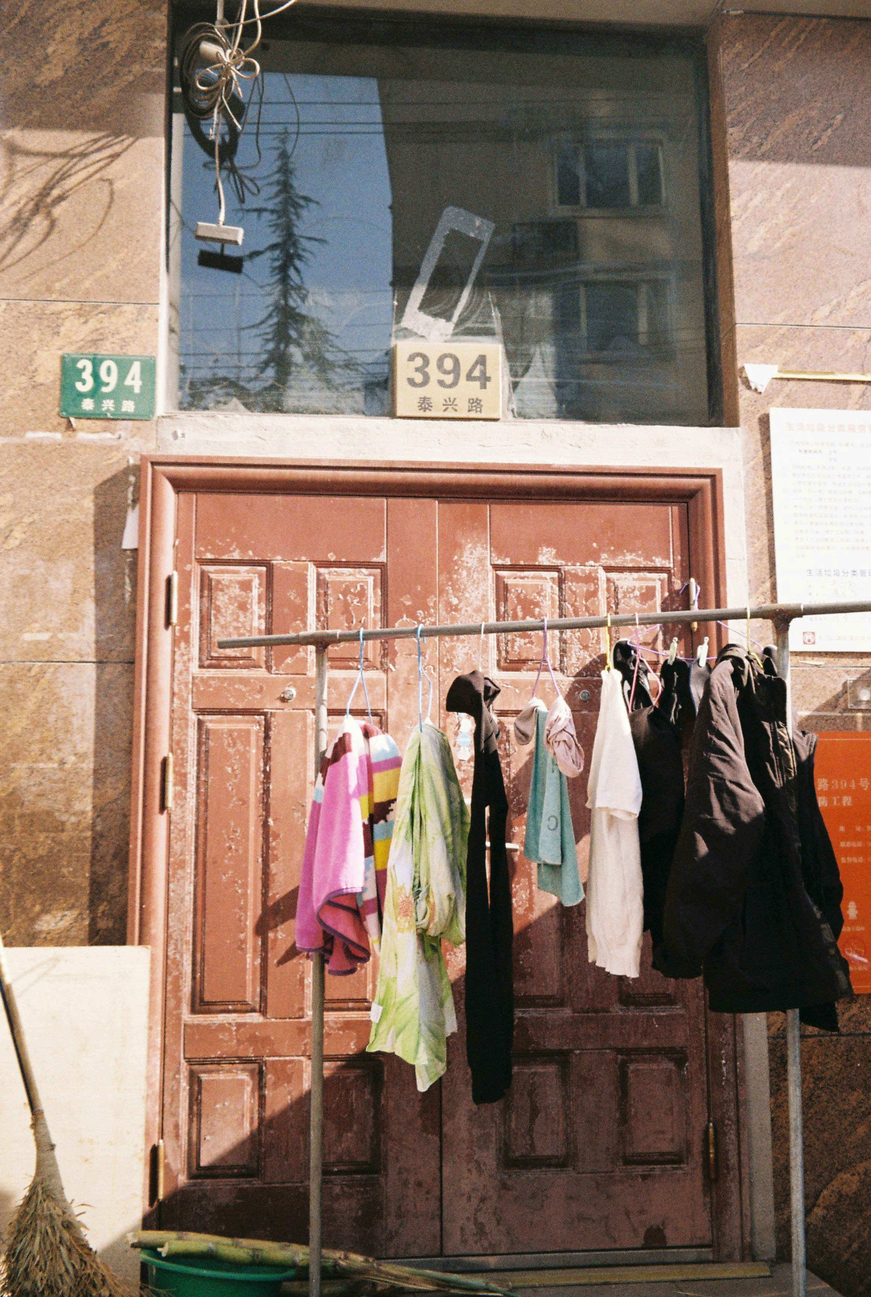 Color on the Threshold: Garments Dangling in Front of a Weathered Urban Door