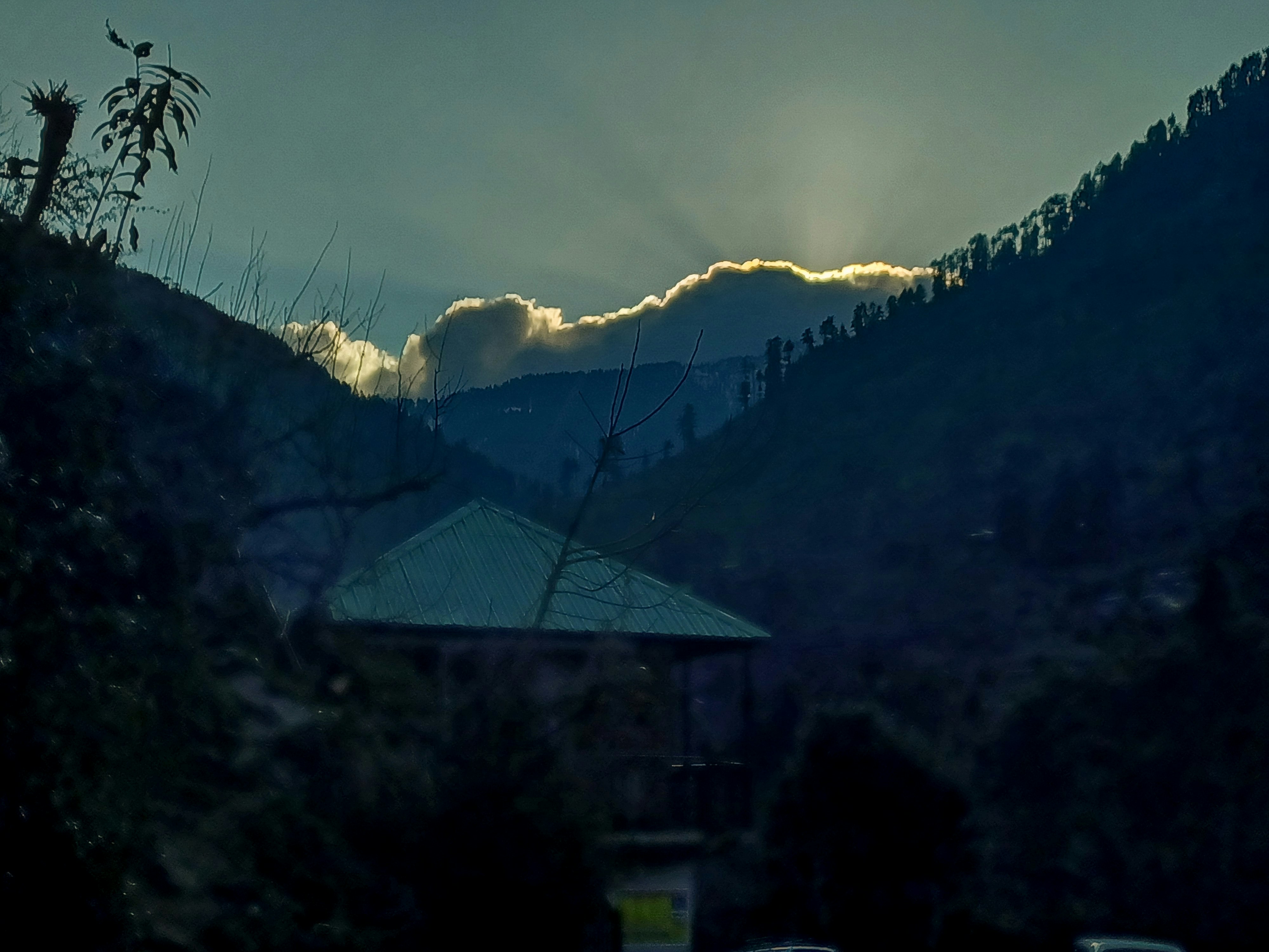 Backlit Ridge Over Silhouette: A Mountain Pavilion at Dusk
