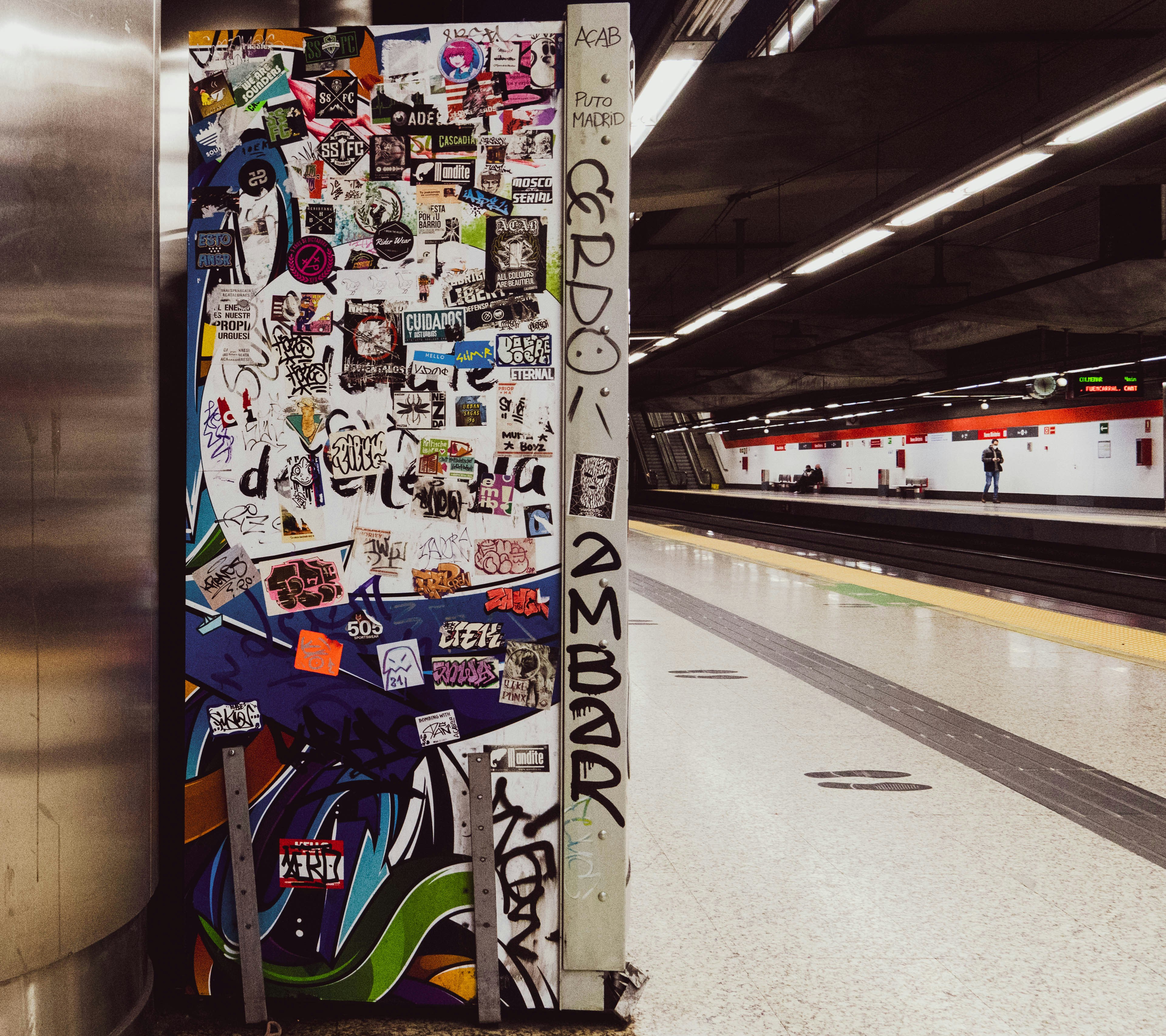 A bunch of stickers on a door in a subway station photo – Free Art ...