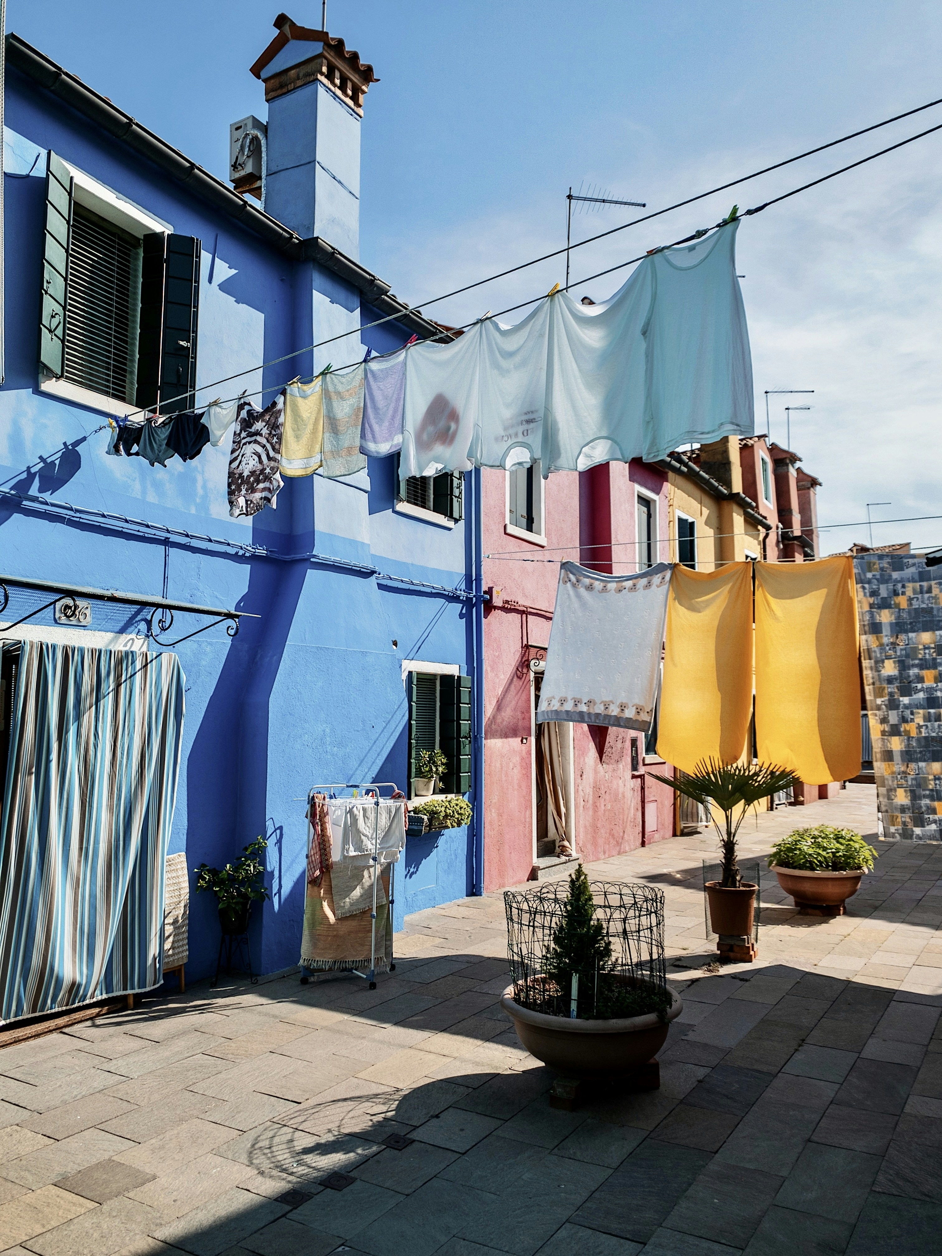 Burano’s Laundry Lane: Threads of Color Across a Sunlit Calle