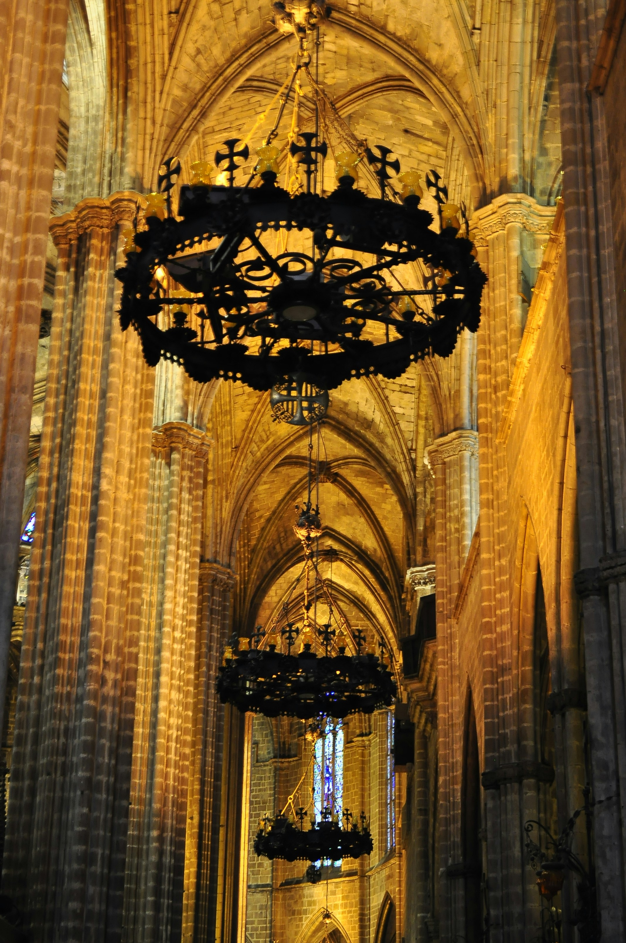Circling Lanterns Over Stone: Chandeliers Guiding Light Through a Gothic Nave