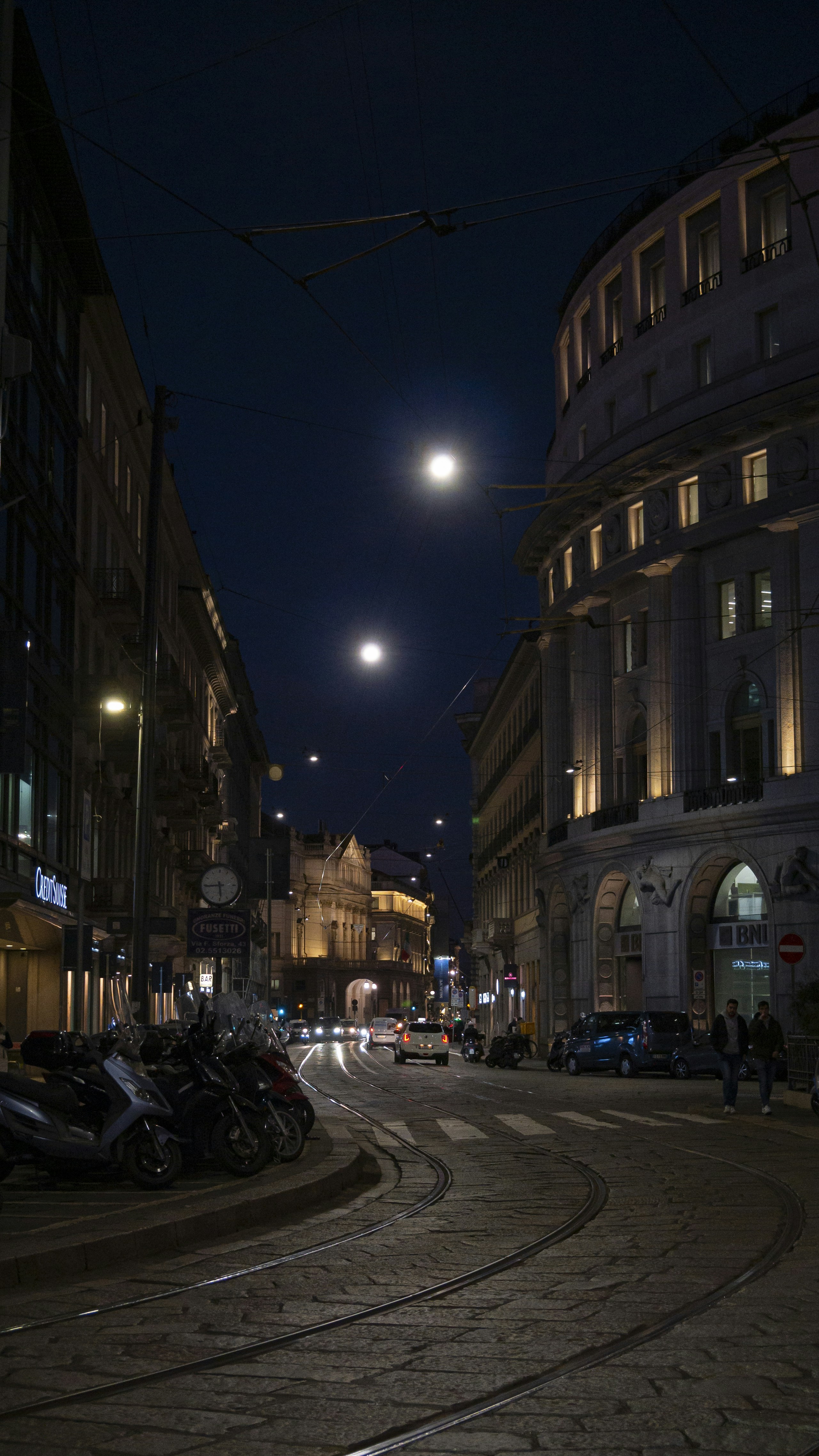 Night Corridor: Tram Tracks Weave Through a Quiet European Street