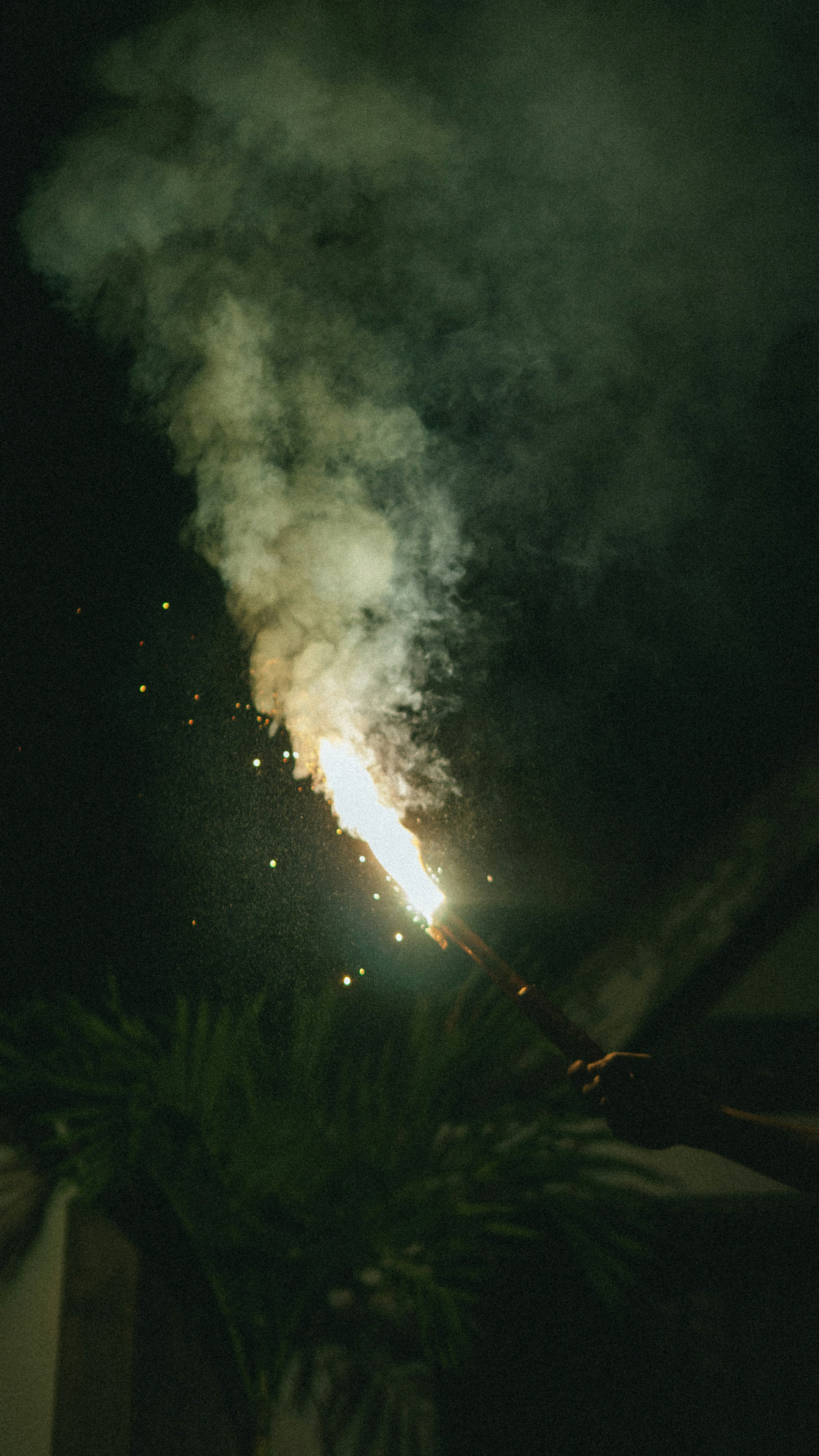 A fireworks is lit up in the night sky photo – Free Torch light Image ...