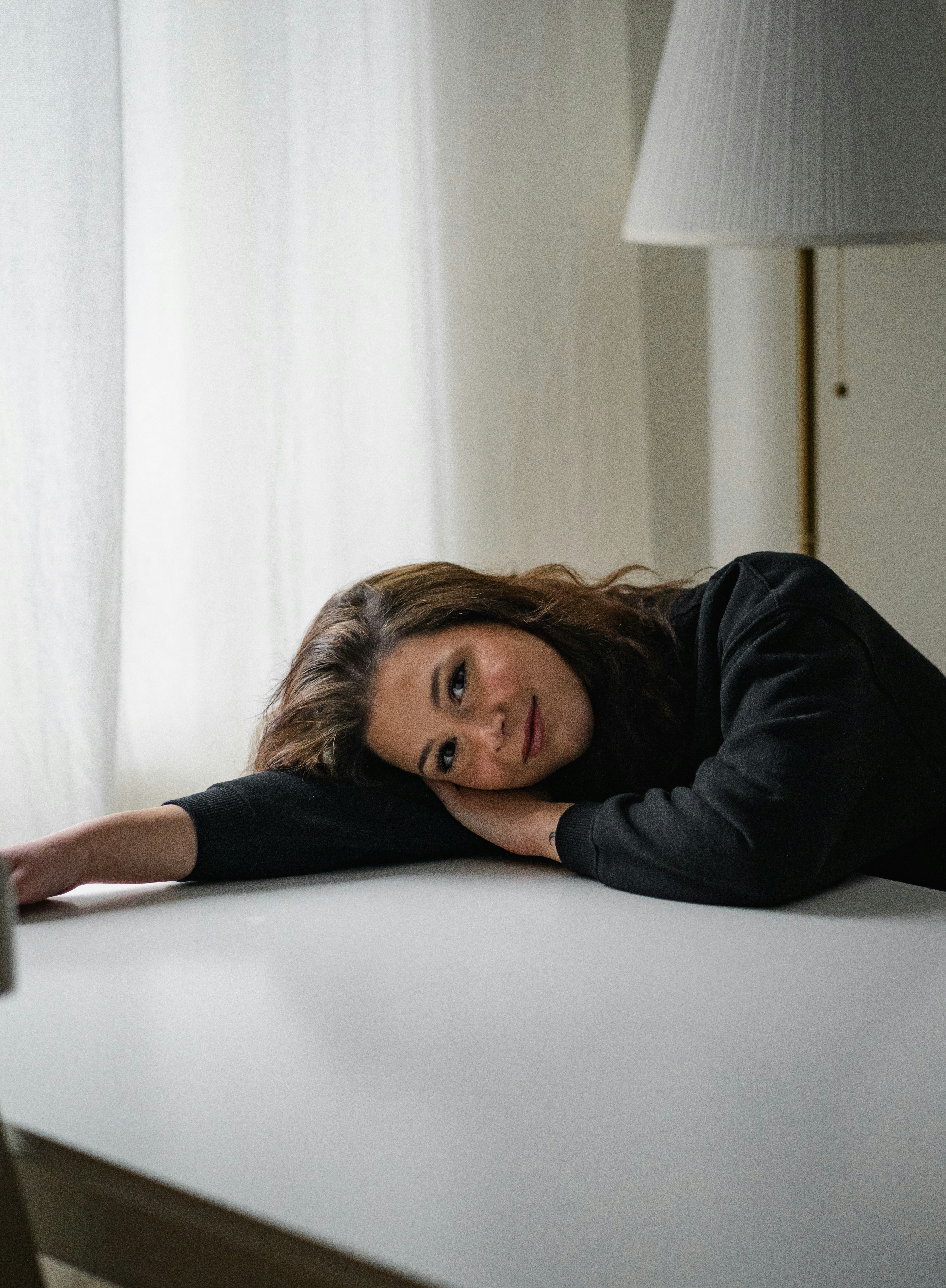 A woman laying her head on a table photo – Free Person Image on Unsplash