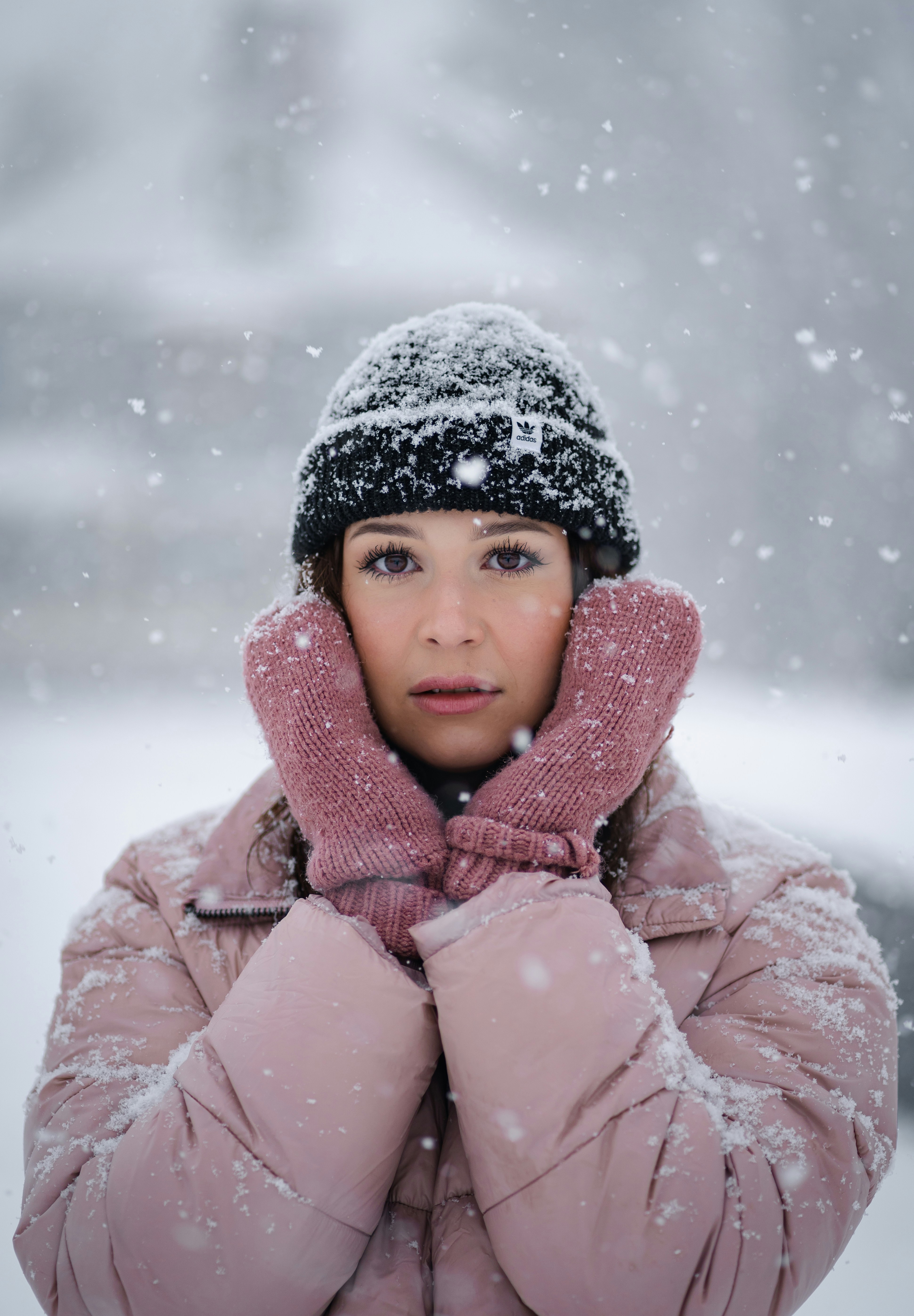 A woman wearing a pink coat and a black hat in the snow photo – Free ...