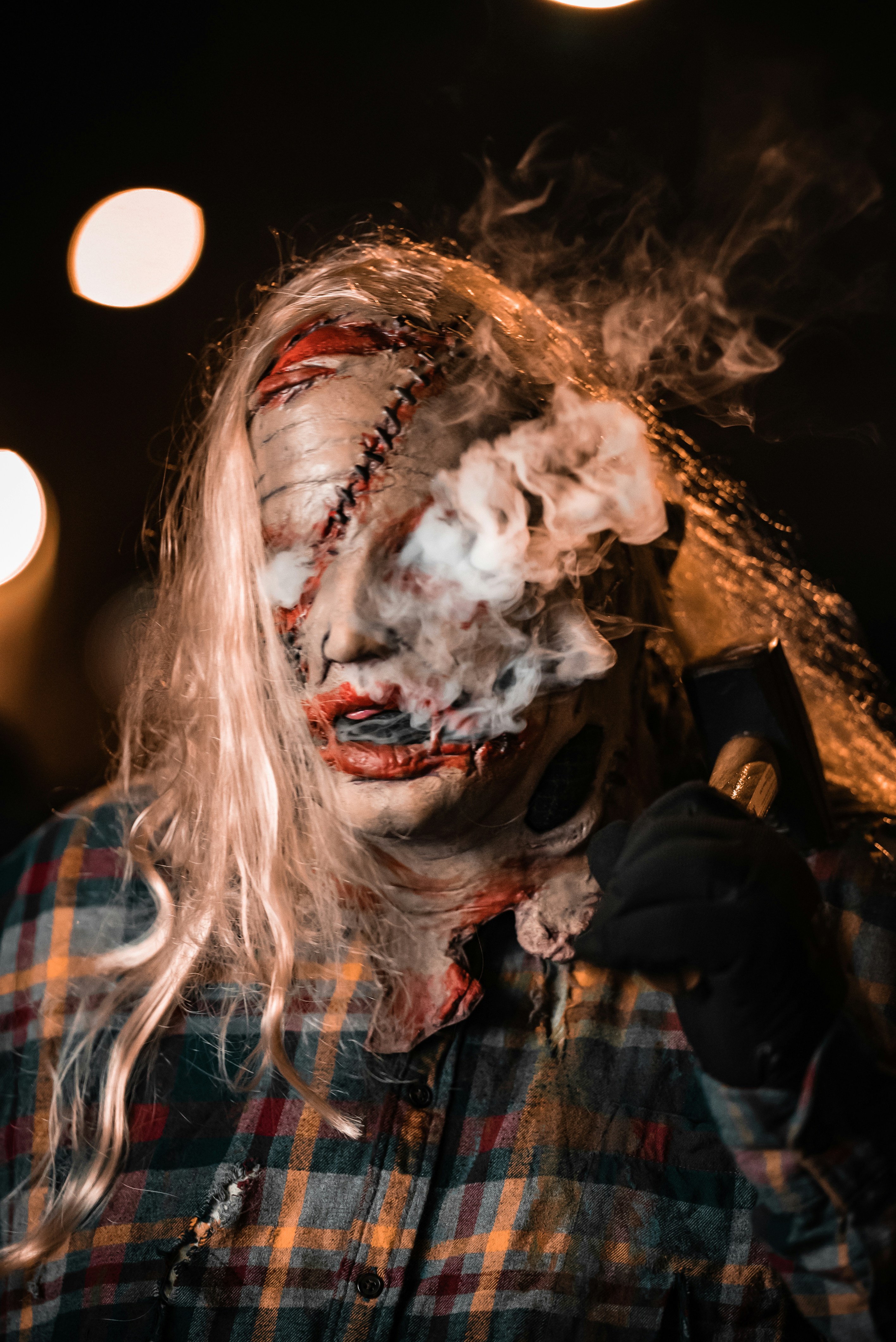 A woman with white hair and makeup smoking a cigarette photo – Free ...