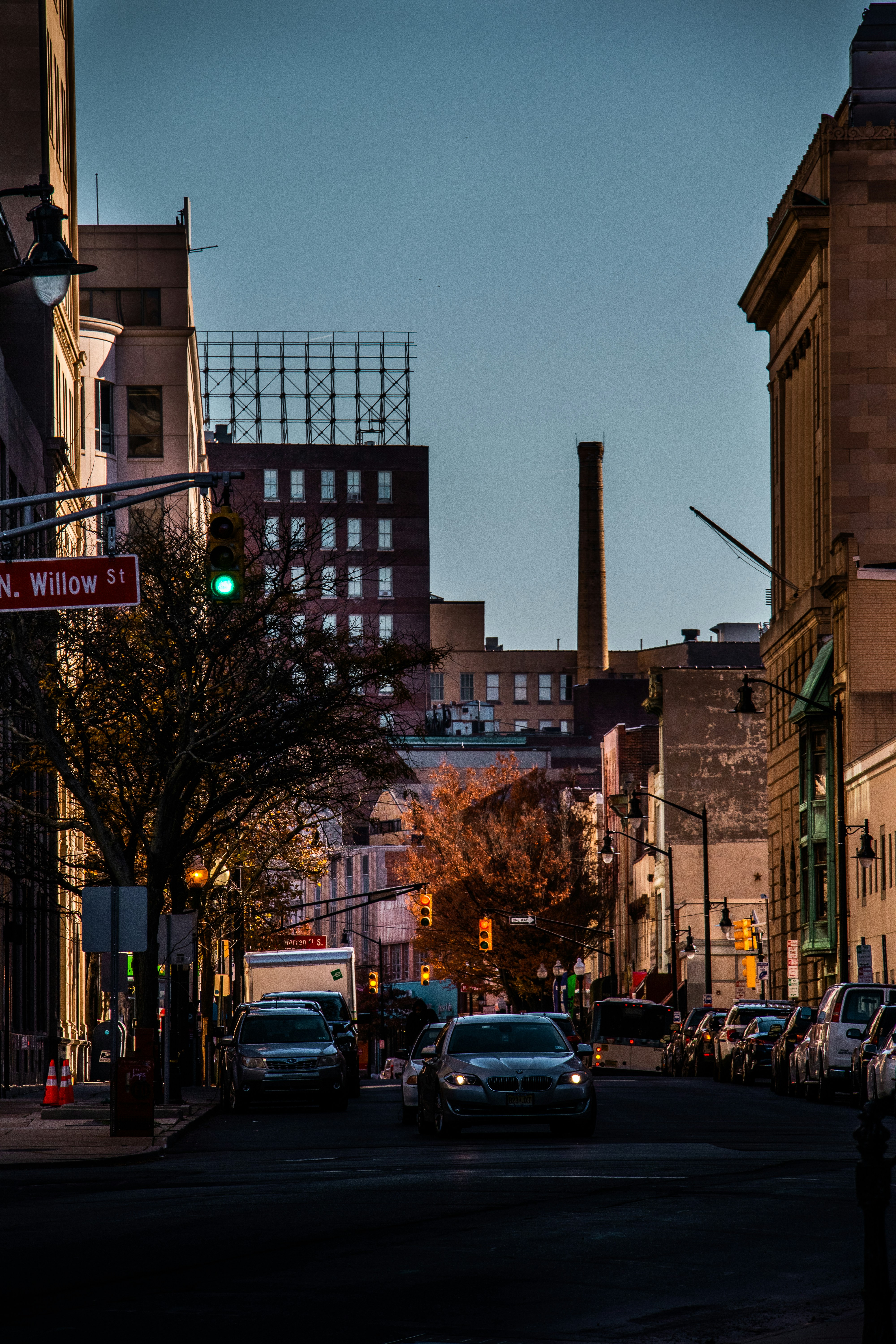 A city street filled with lots of traffic next to tall buildings photo ...