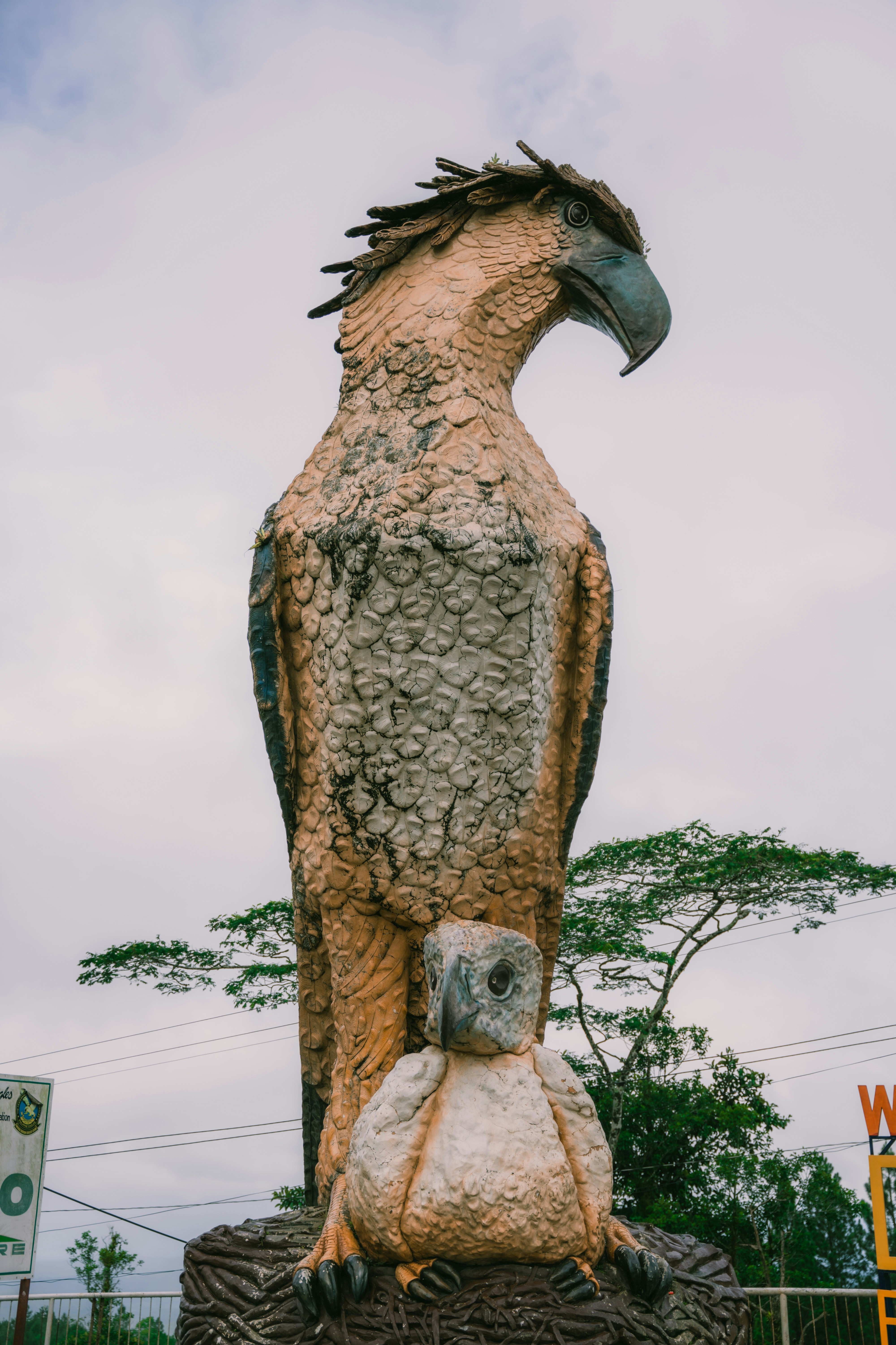 a statue of a bird sitting on top of a bird nest