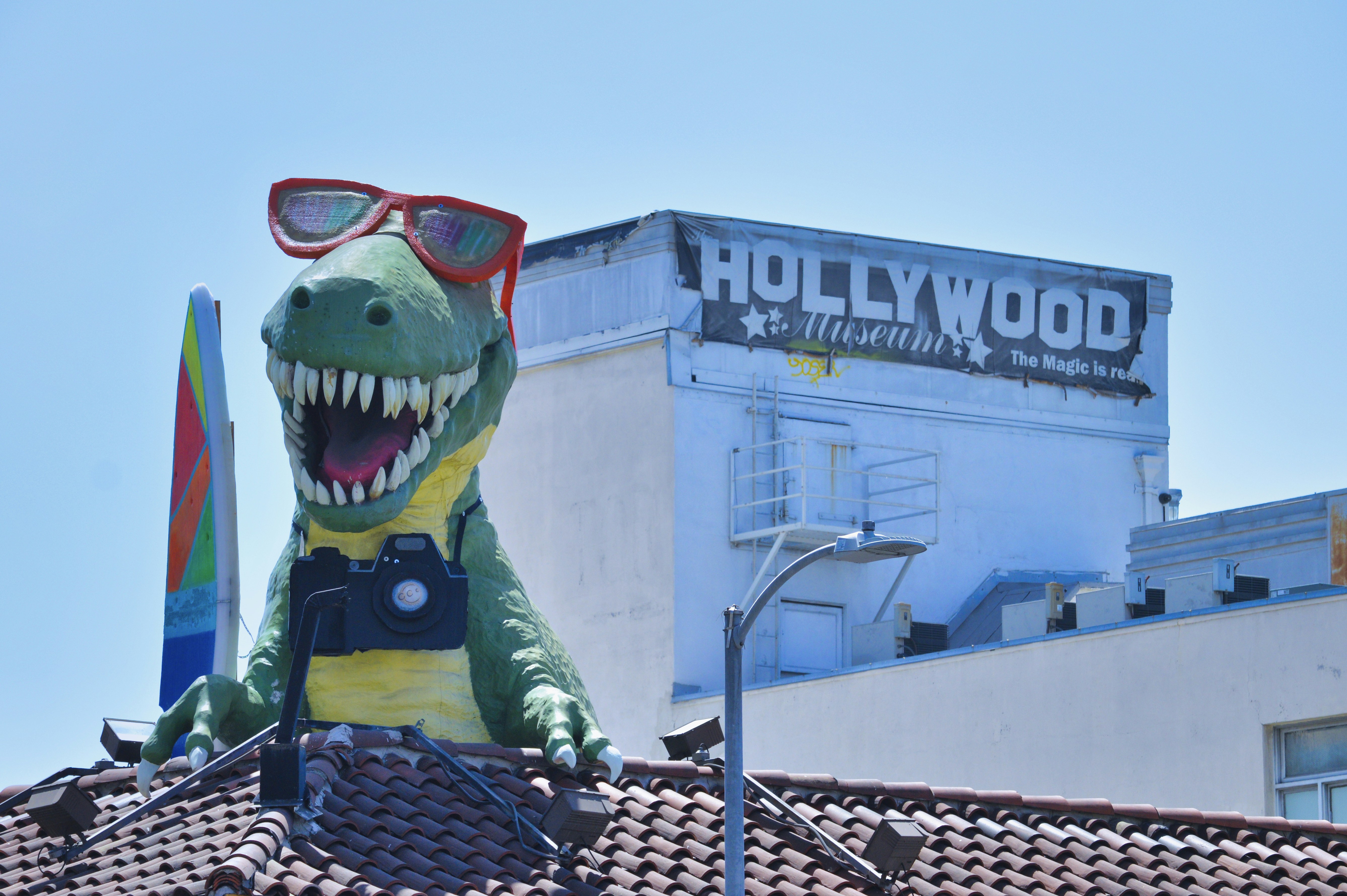 Rooftop Rex: Sunglassed Dino Over Hollywood's Skyline