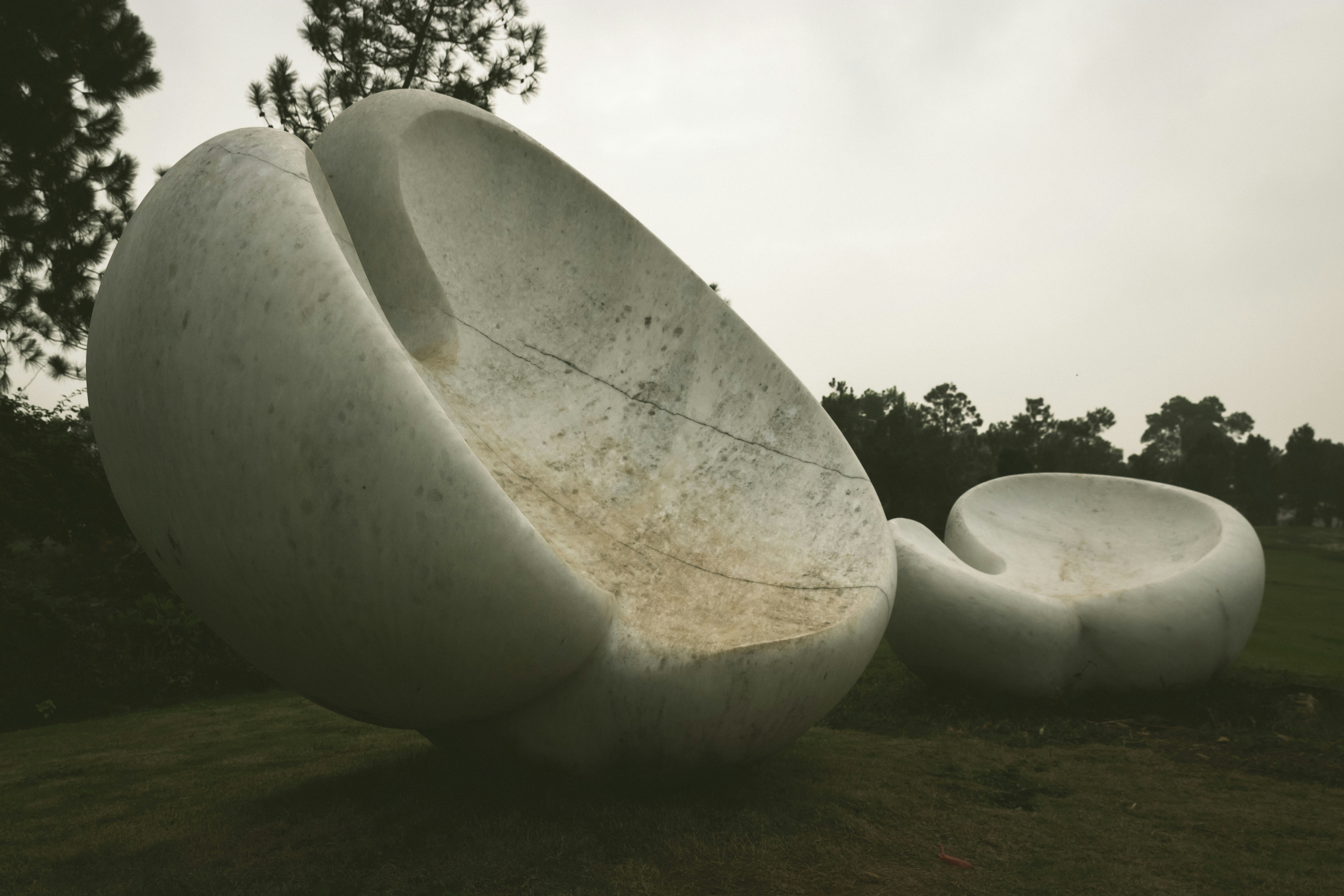 A large white object sitting on top of a lush green field photo – Free ...