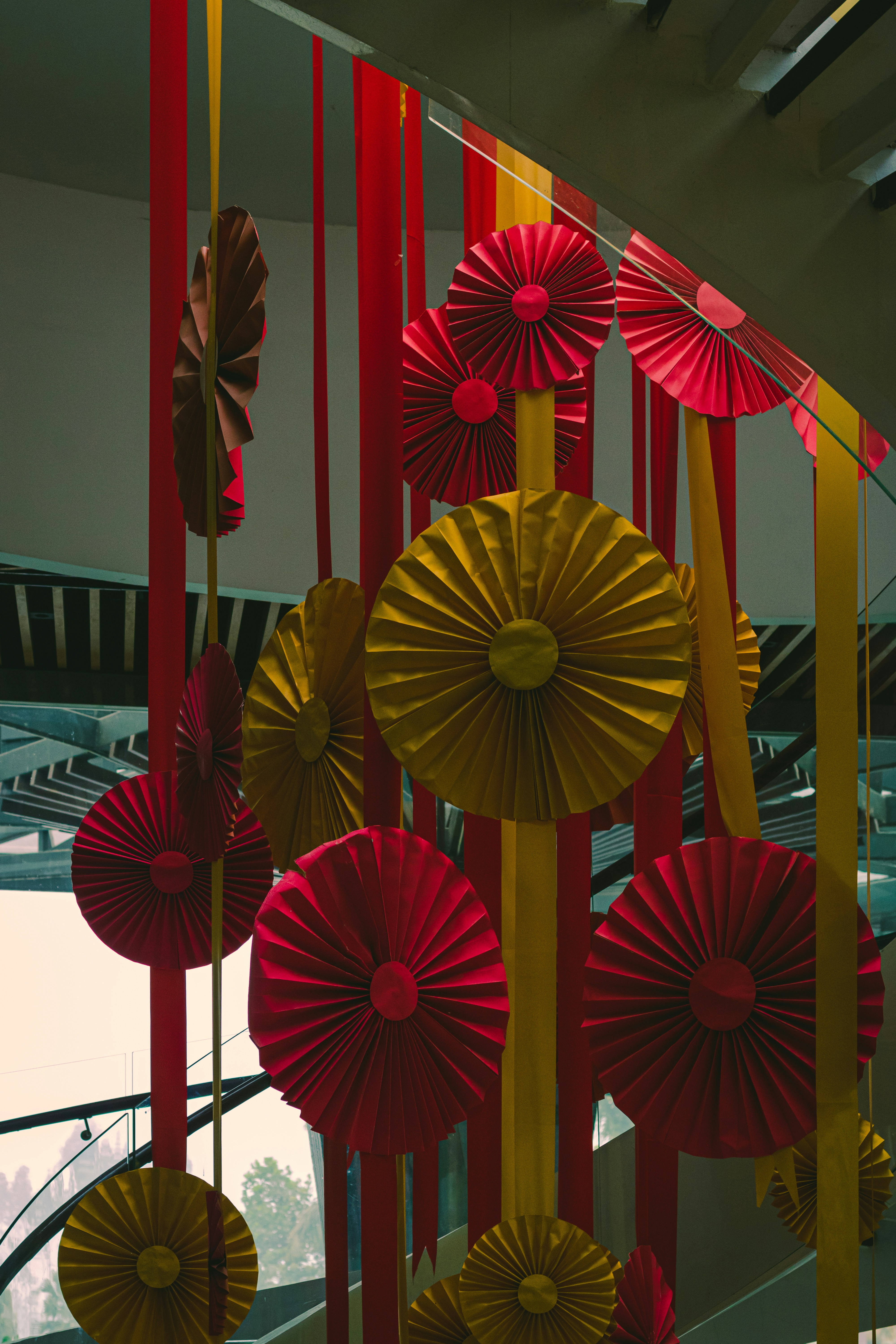 A bunch of red and yellow decorations hanging from a ceiling photo ...