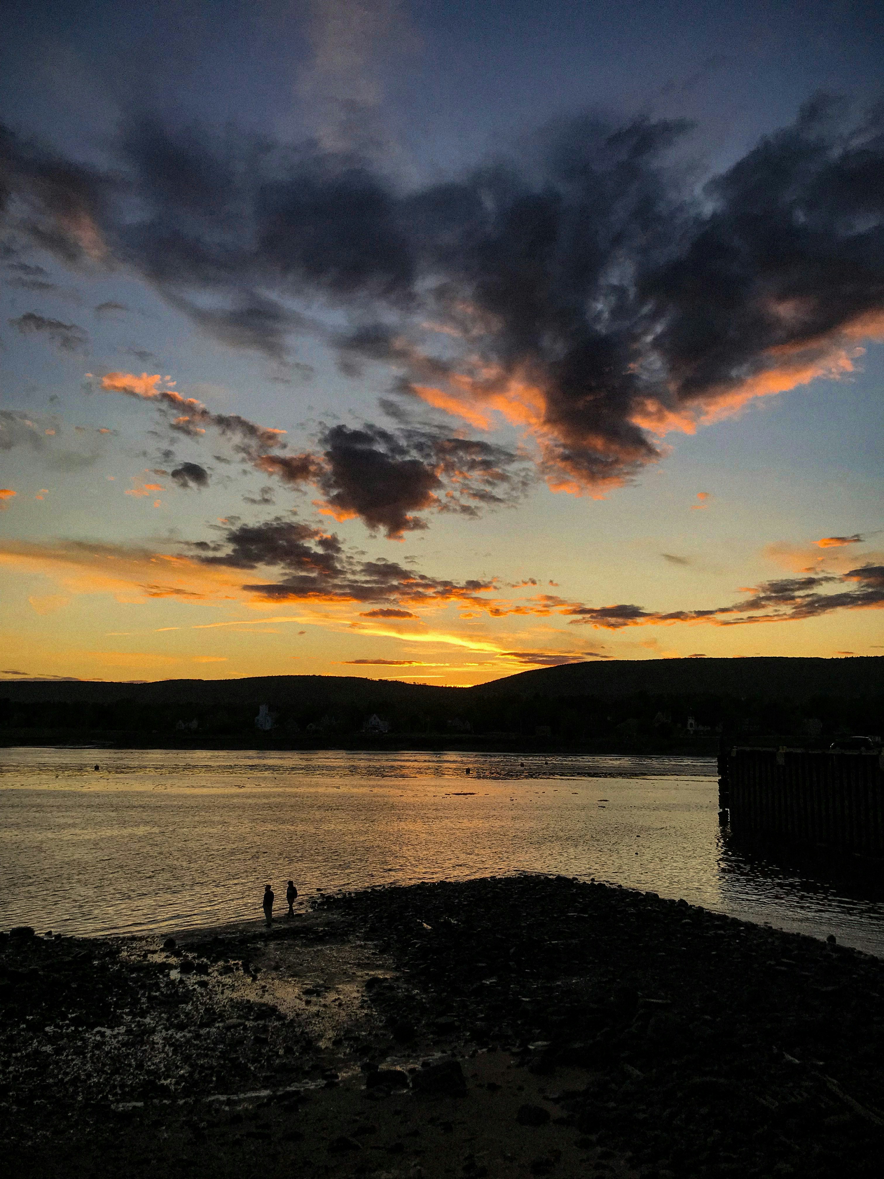 Ember Skies Over a Quiet Pebble Shore at Sunset