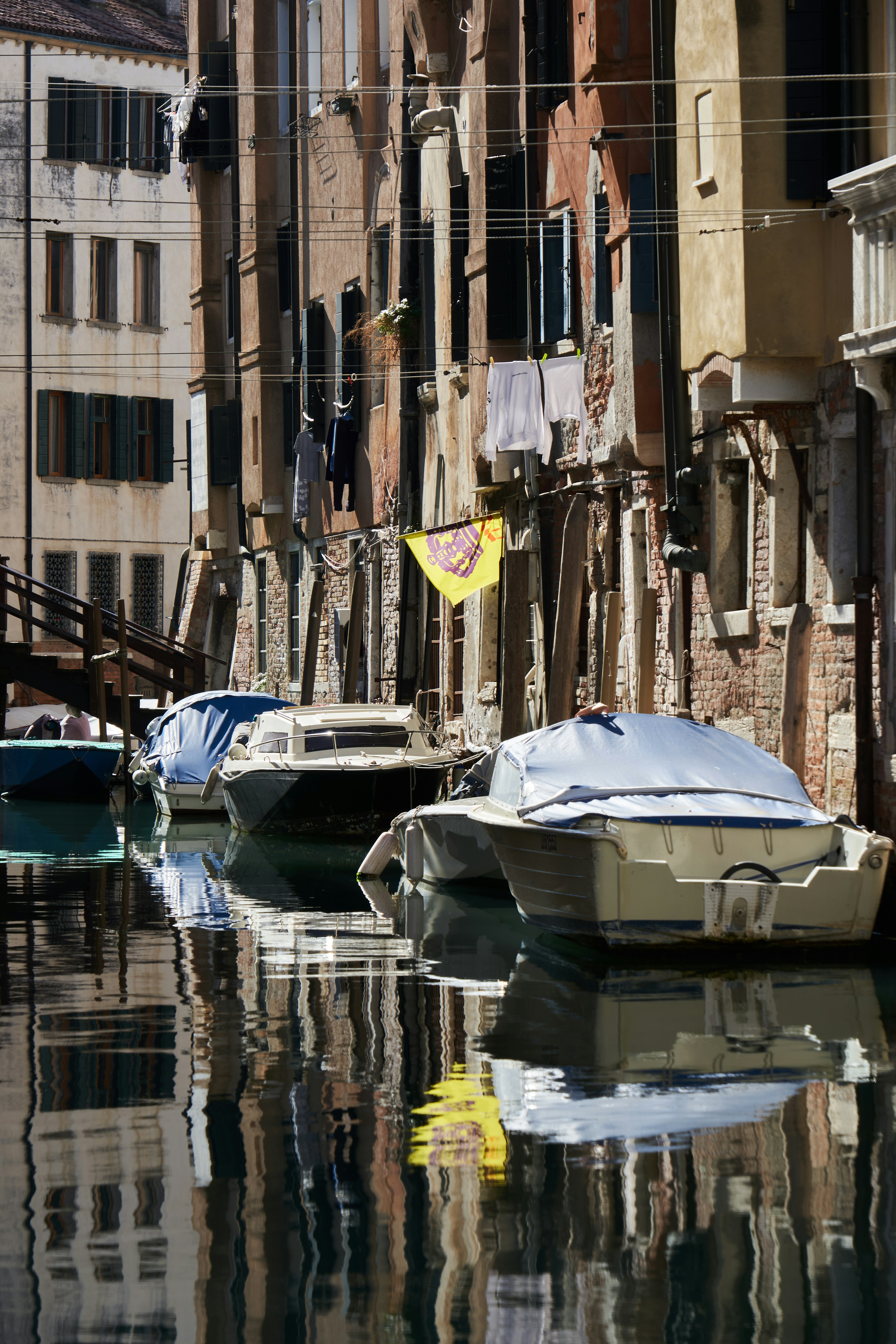 Canal Echoes: Boats, Brick Facades, and Laundry in Venice