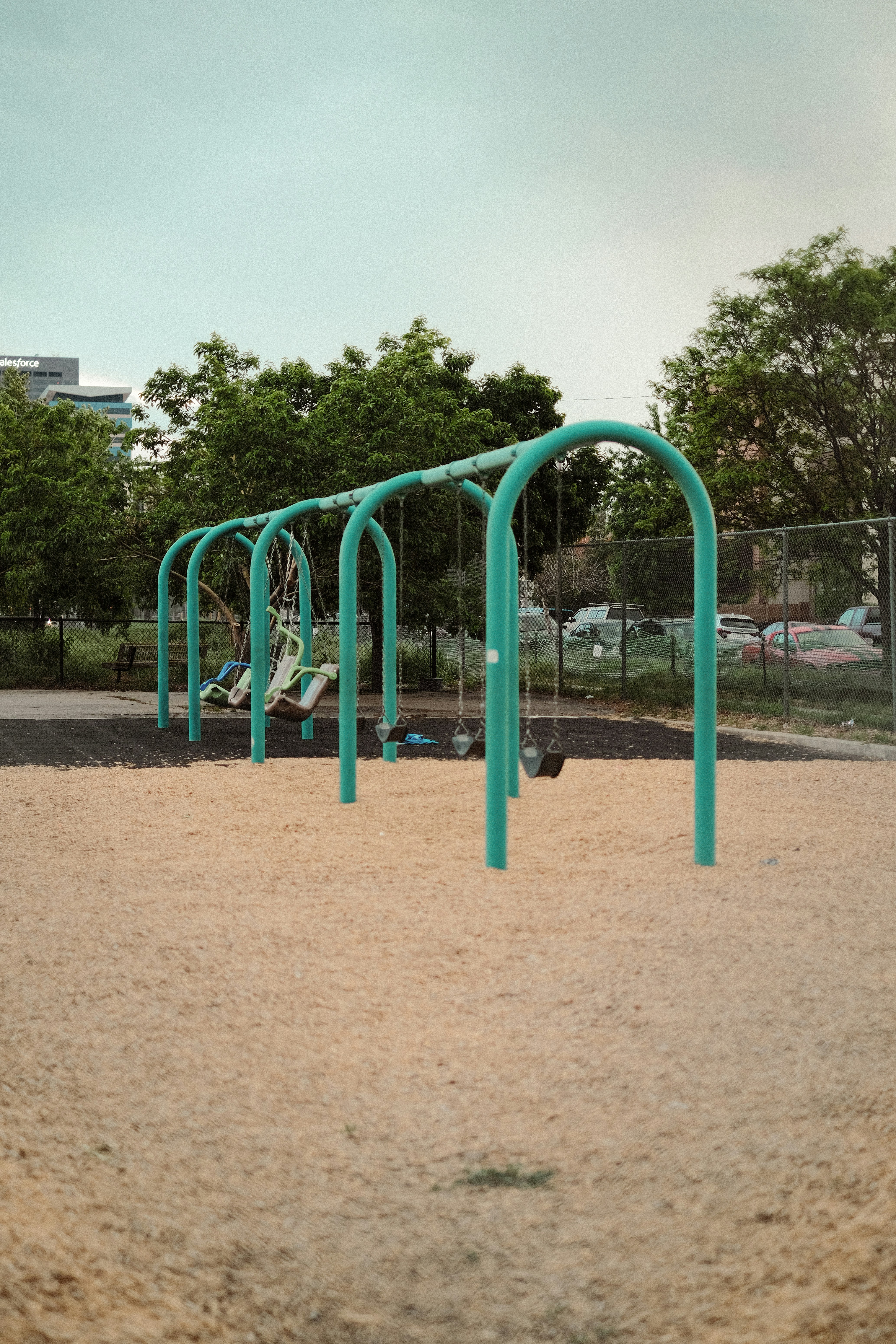 A playground with swings and a slide in a park photo – Free Denver ...