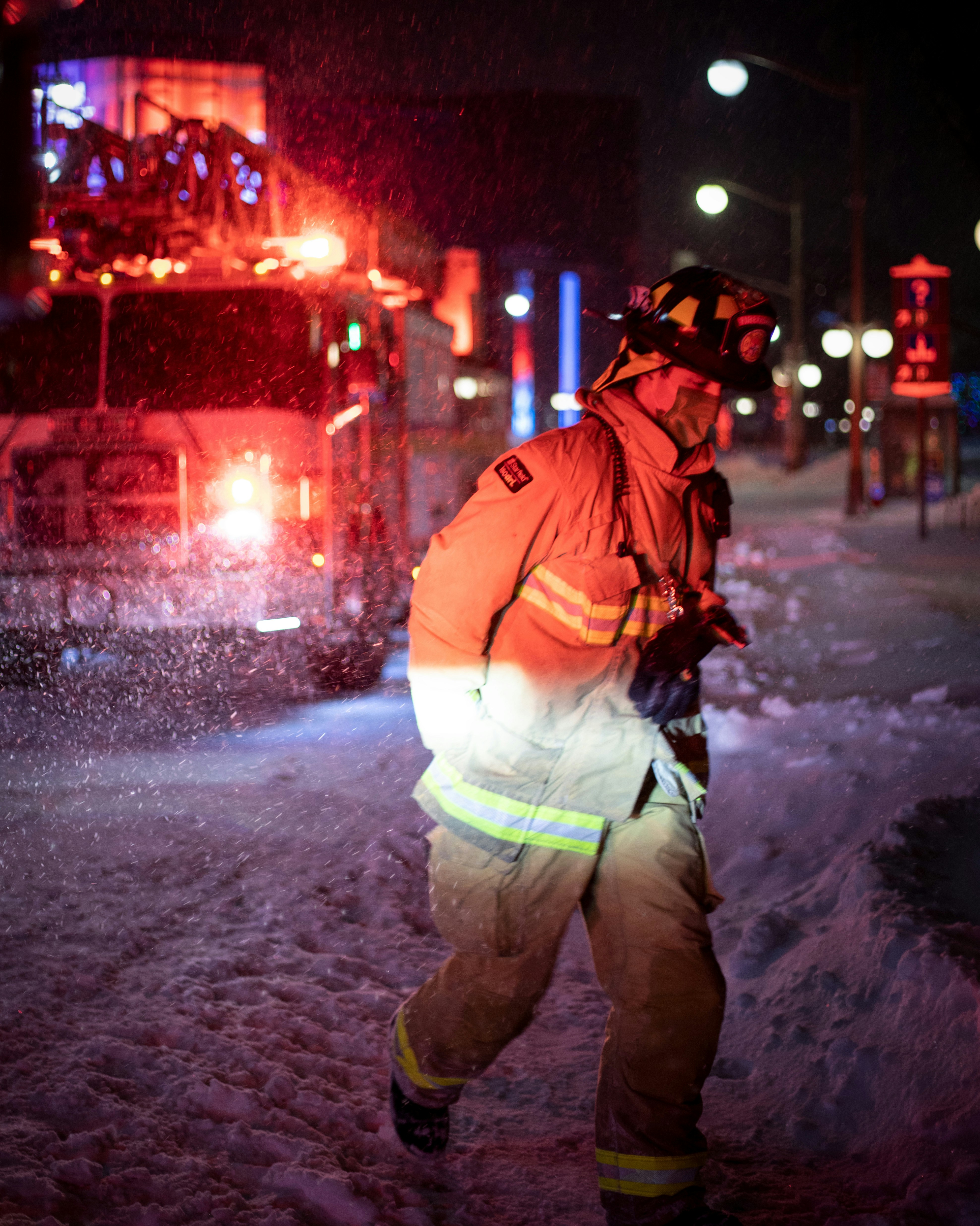 A firefighter walking through the snow at night photo – Free Ottawa ...