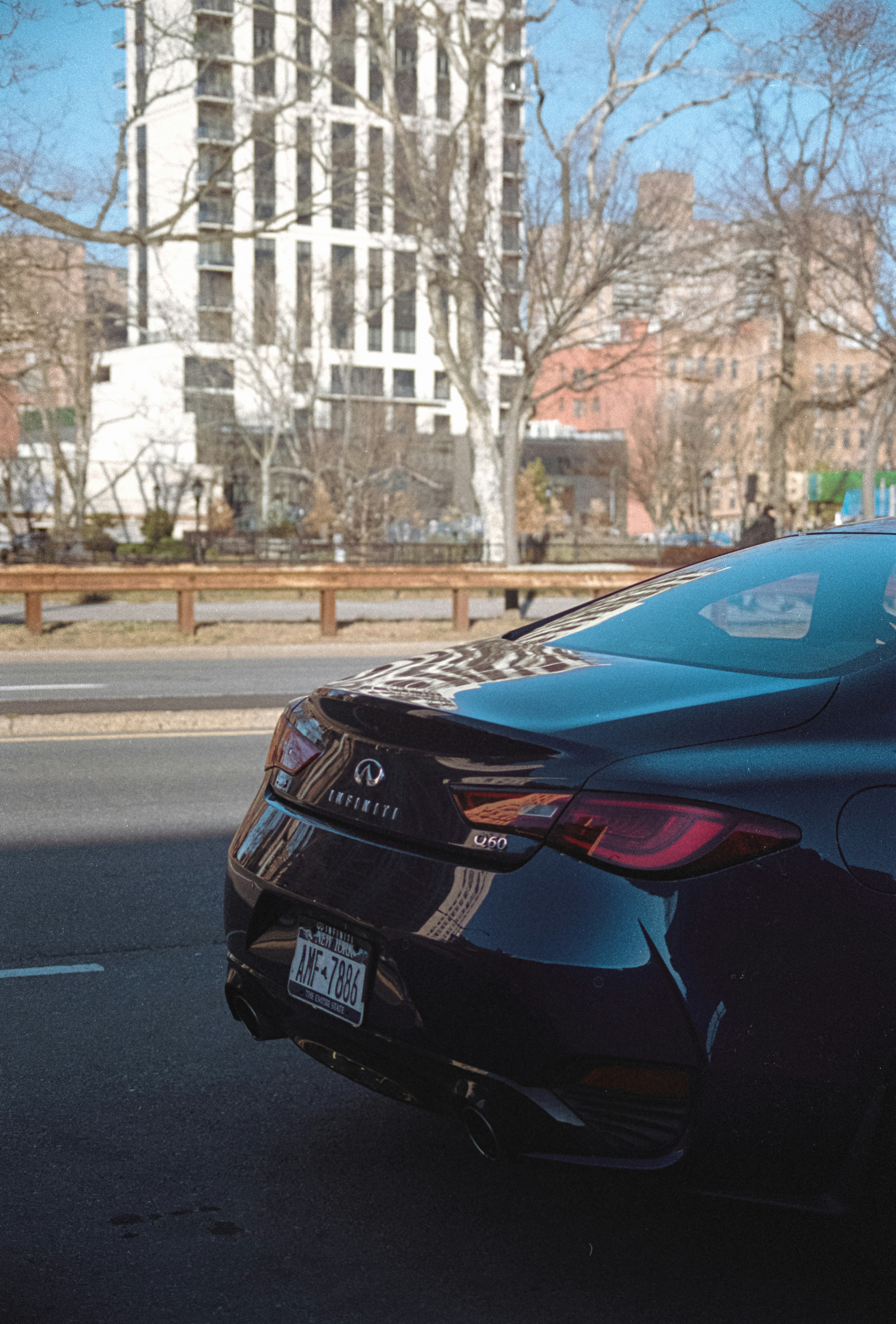 Rearward in the City: A Glossy Infiniti Against Urban Lines