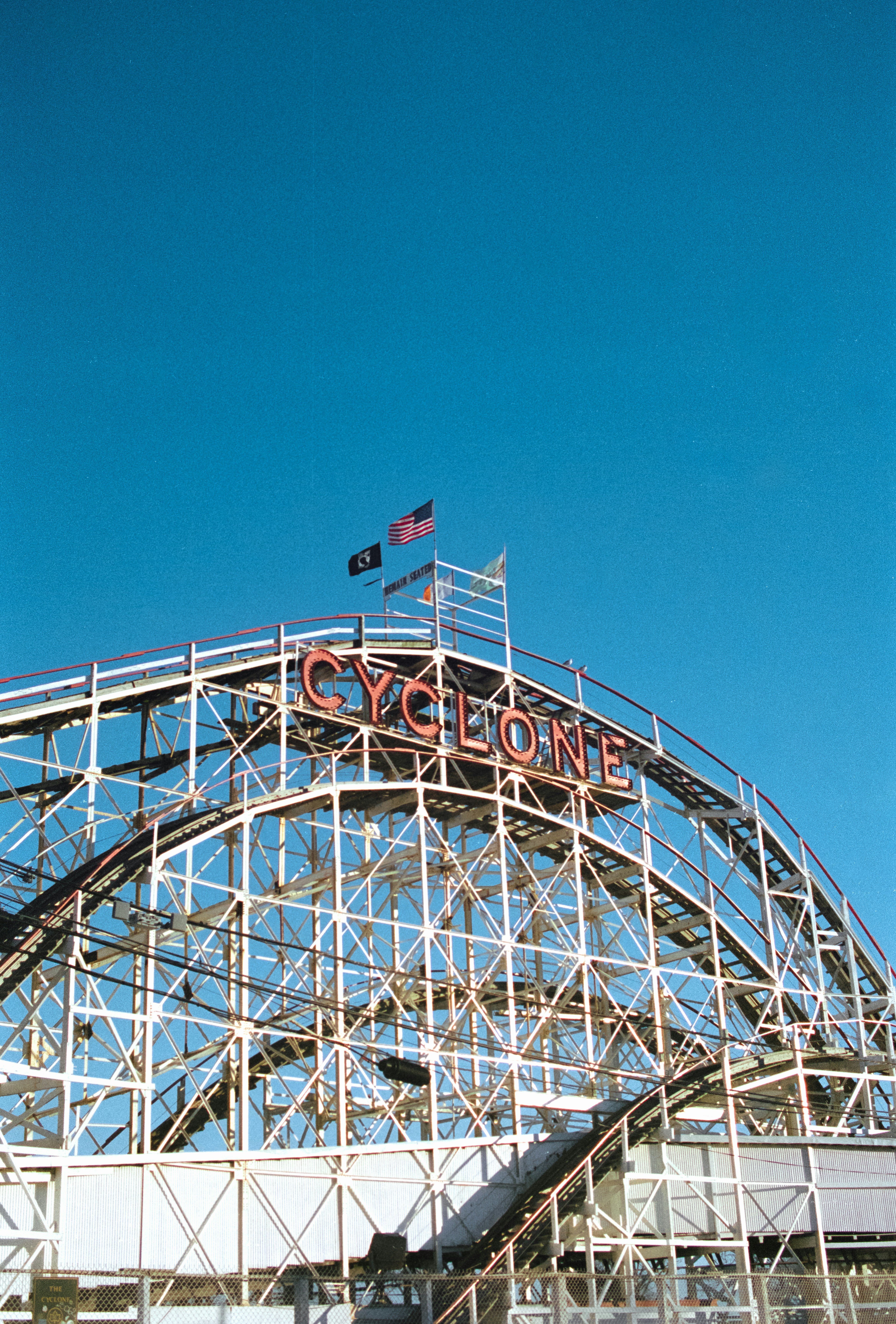 A large metal structure with a flag on top of it photo – Free Roller ...